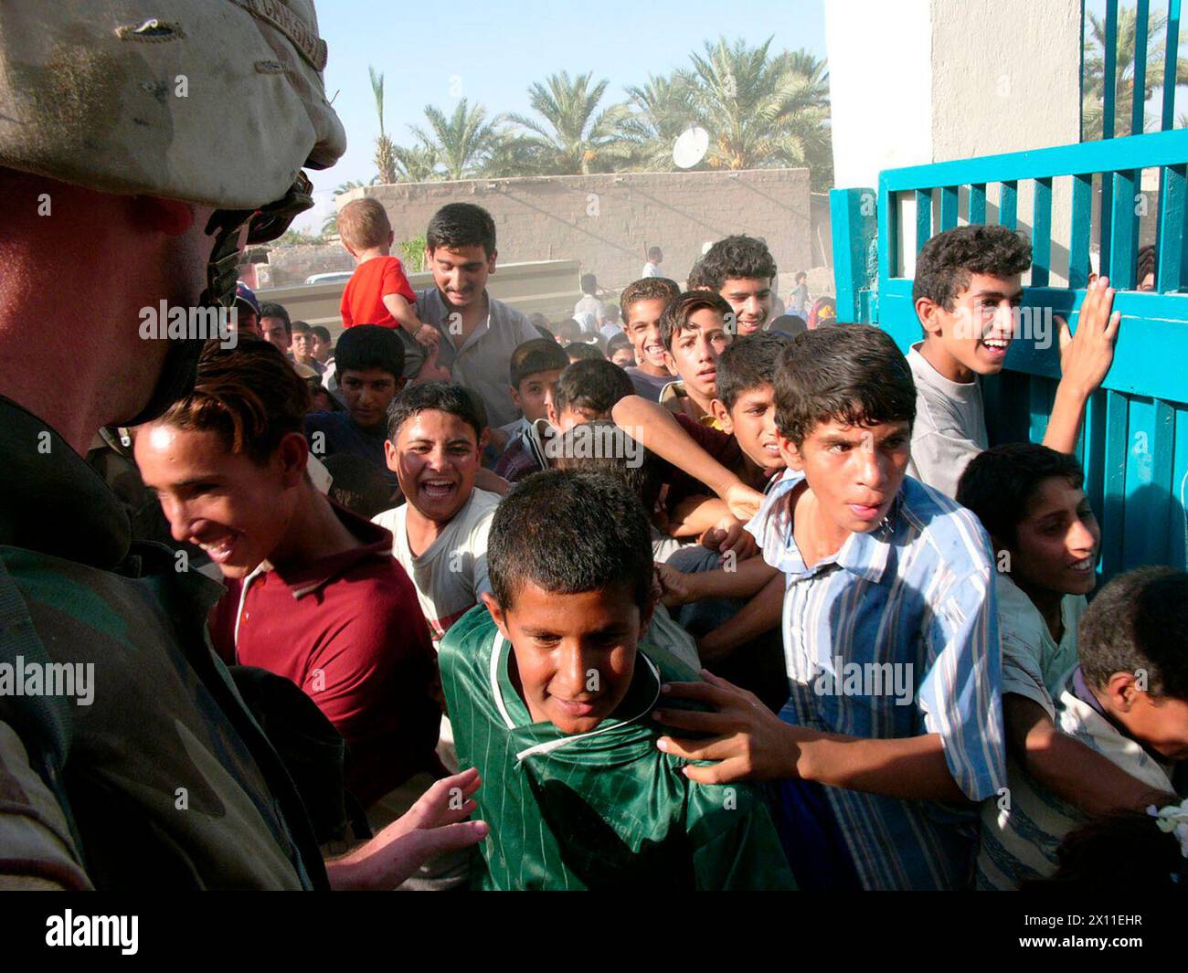 Children rush through the school gates to a festival in their school ...