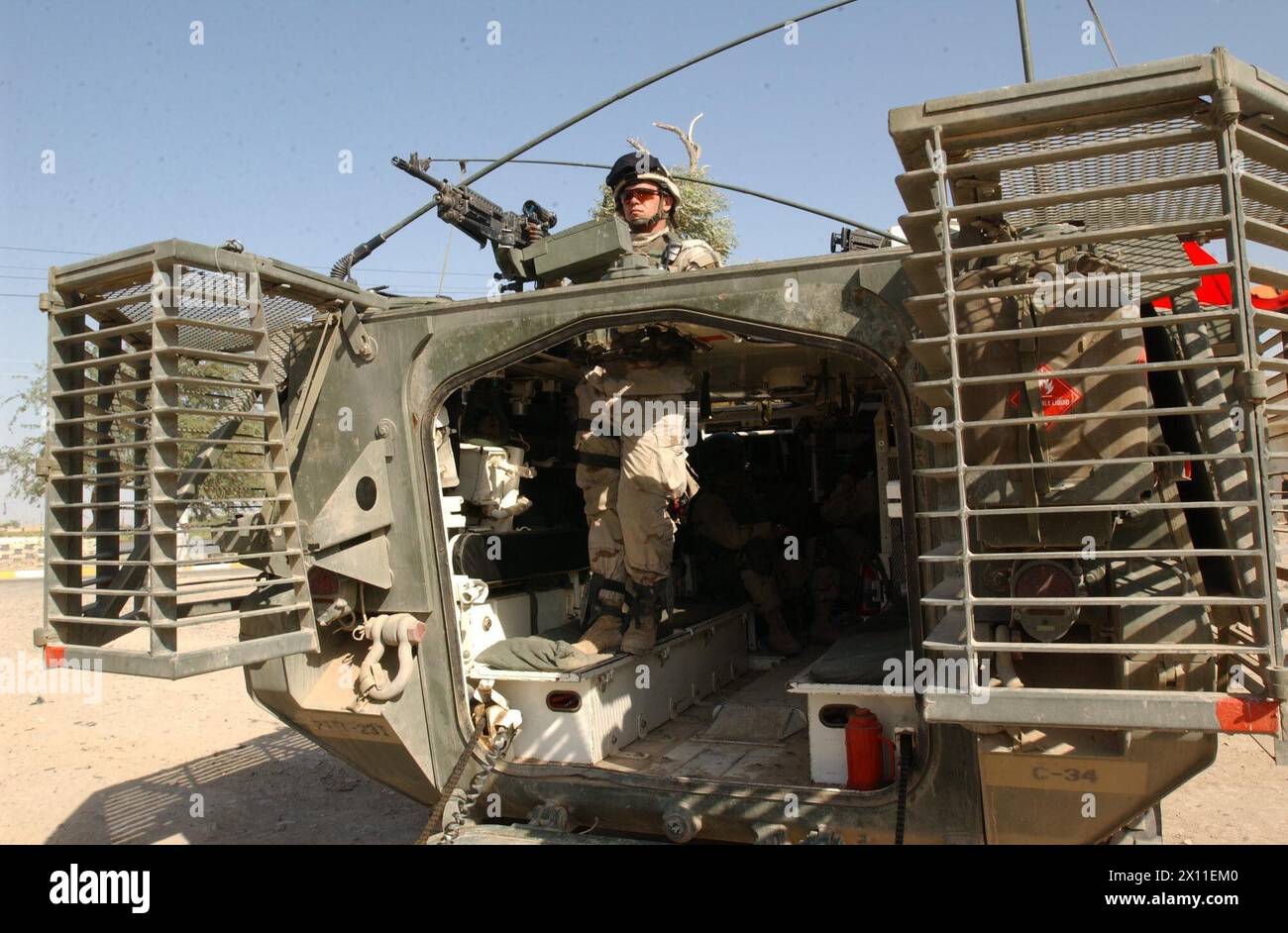 From the hatch of a Stryker vehicle, Spc. Brian Weinberger, secures his ...