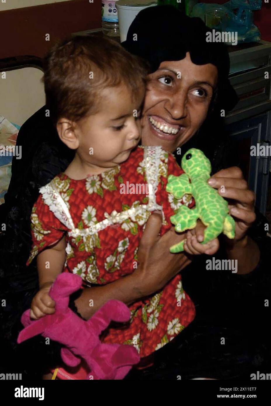 A woman with her child in the Baghdad Childrens Hospital splits a wide ...
