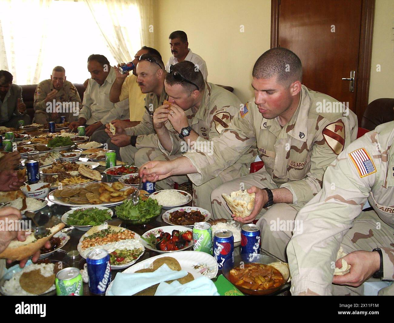 Staff Sgt. Dave Gurba helps himself to a few of the dishes prepared by ...