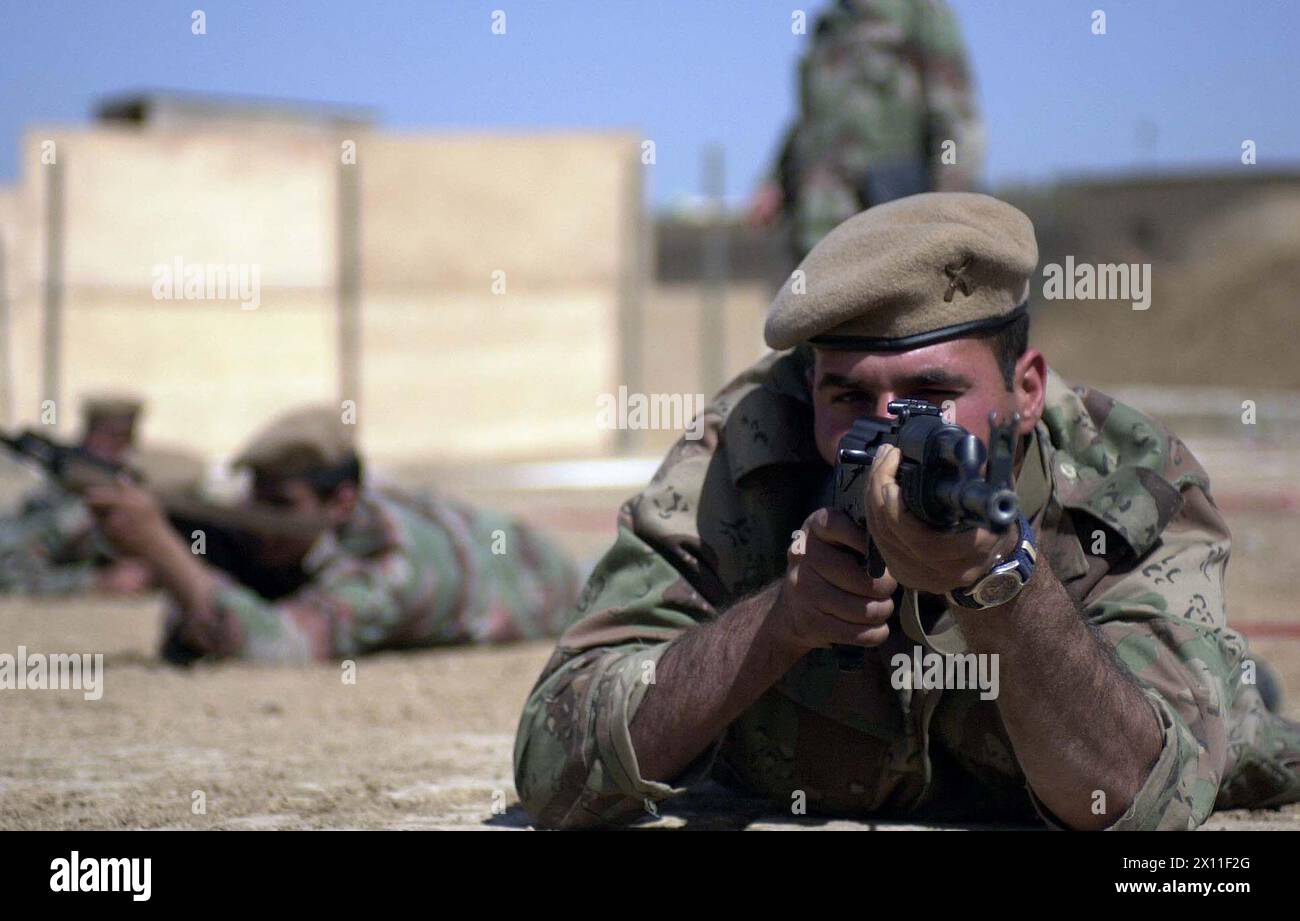 An Iraqi soldier from 2nd Company, 3rd Battalion keeps watch down the ...