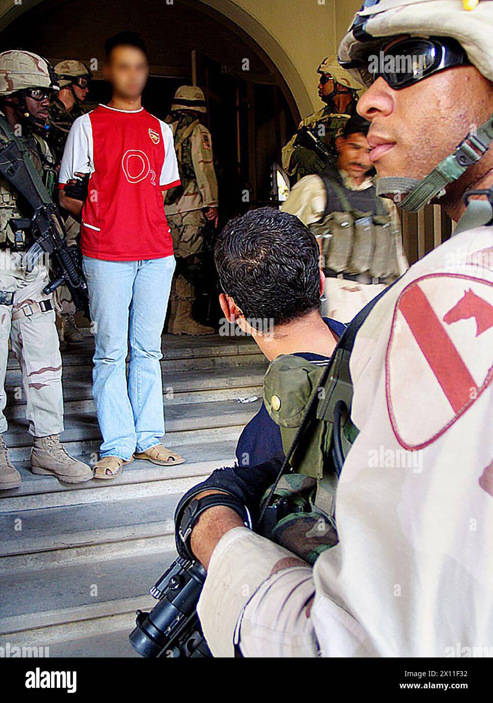 Pfc. Richard Thomas (right) holds one of two young men arrested during ...