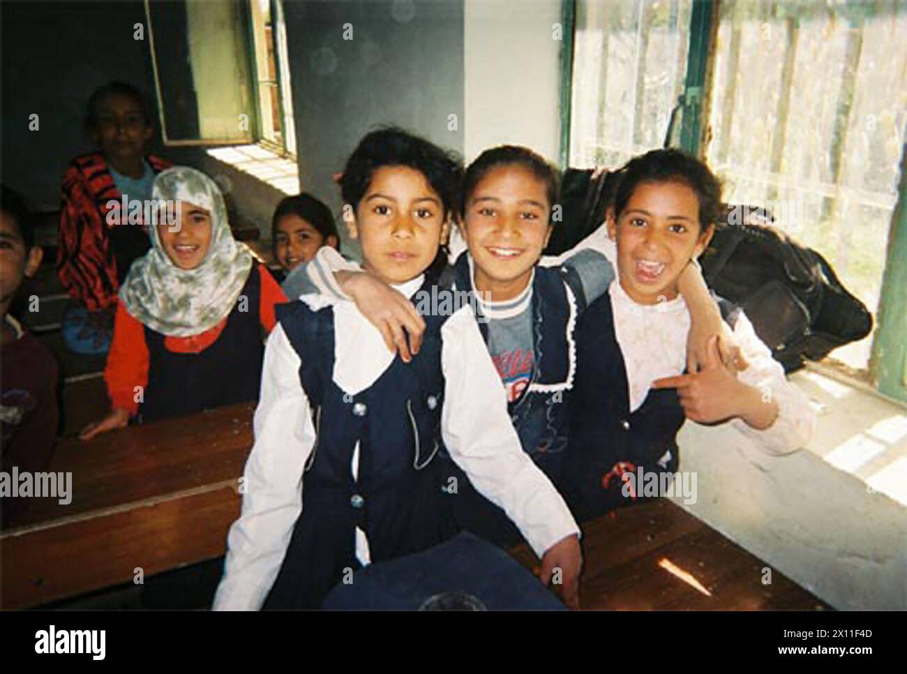 Three Iraqi school girls pose for the American Soldiers' cameras. These ...