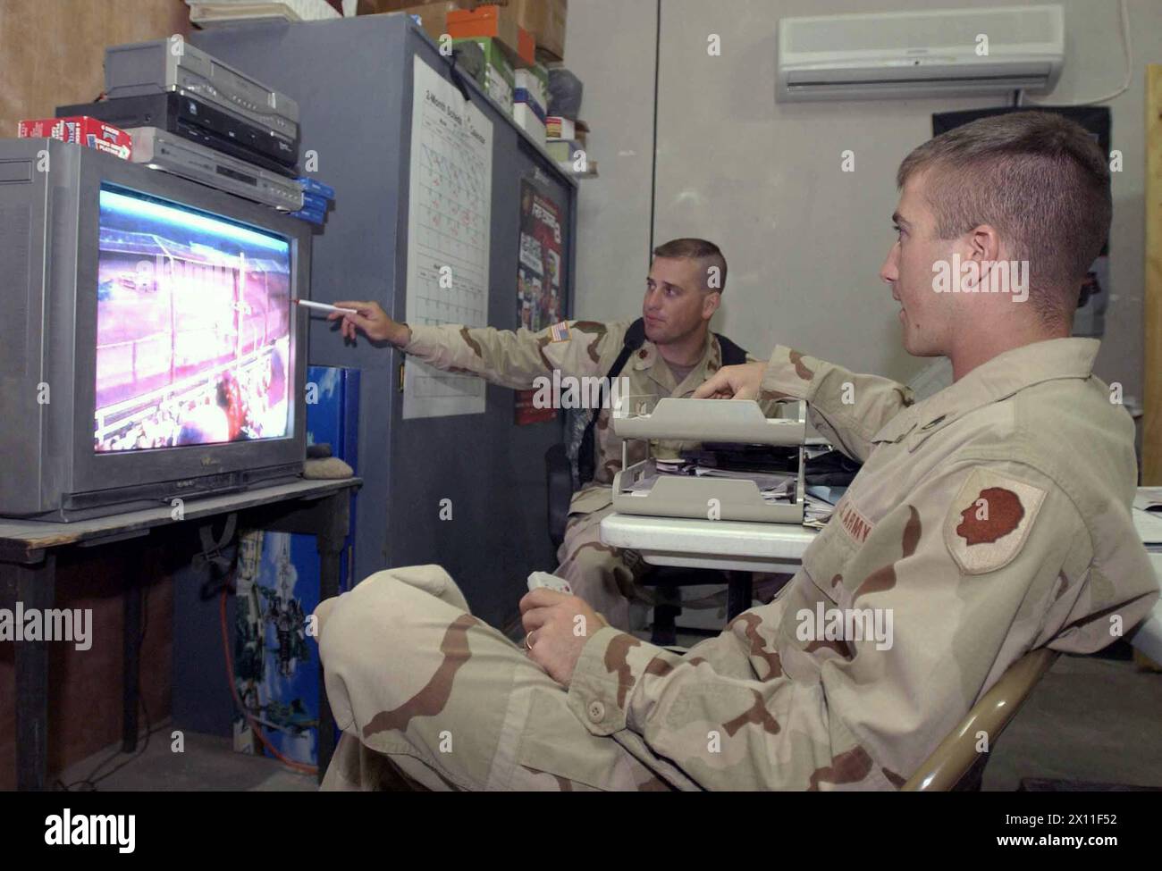 Maj. Eric Little points out an error a race car made on a turn to his ...