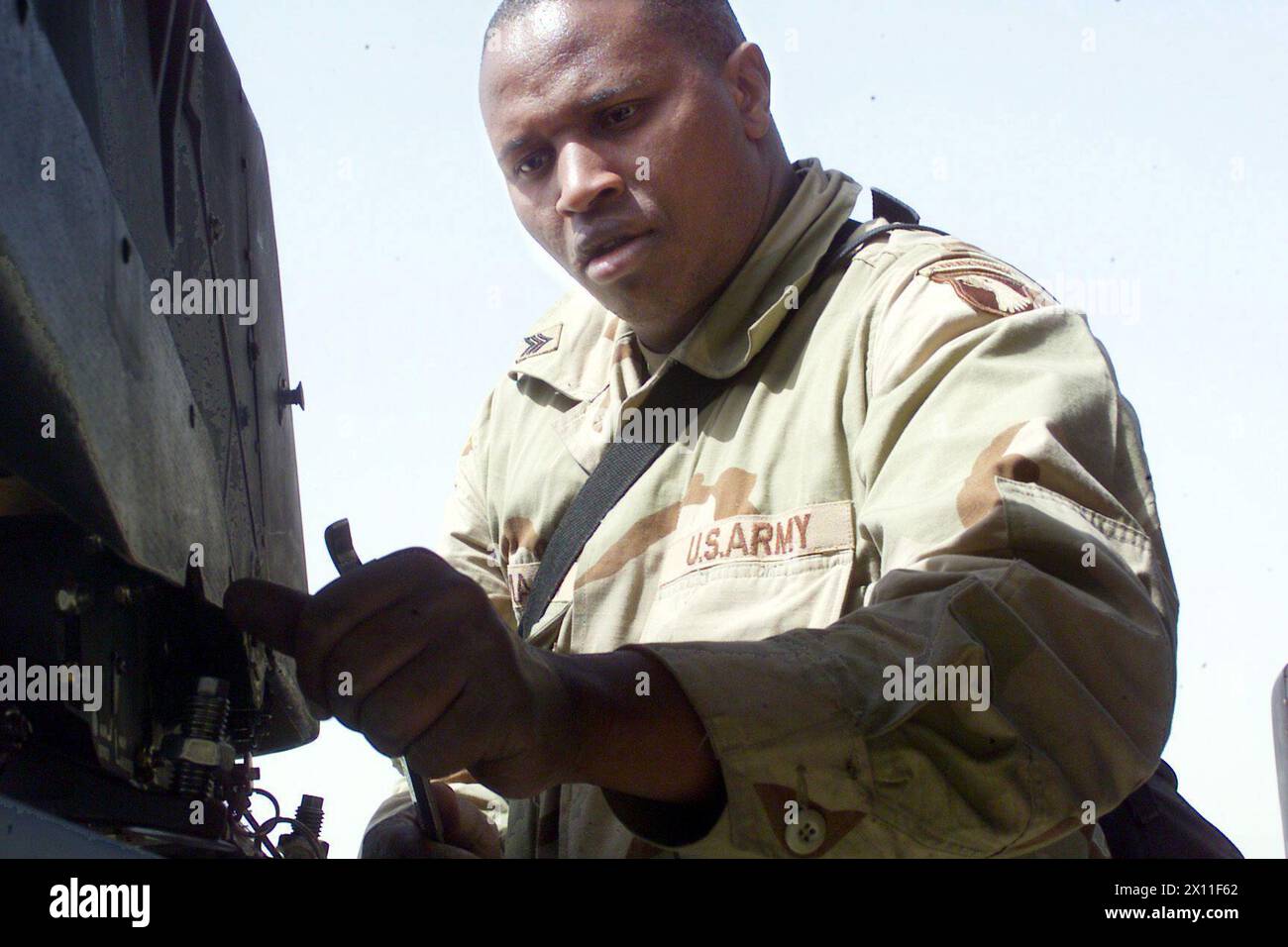 Original Caption: Sgt. Peter Magua, an AH-64 Apache mechanic with D ...