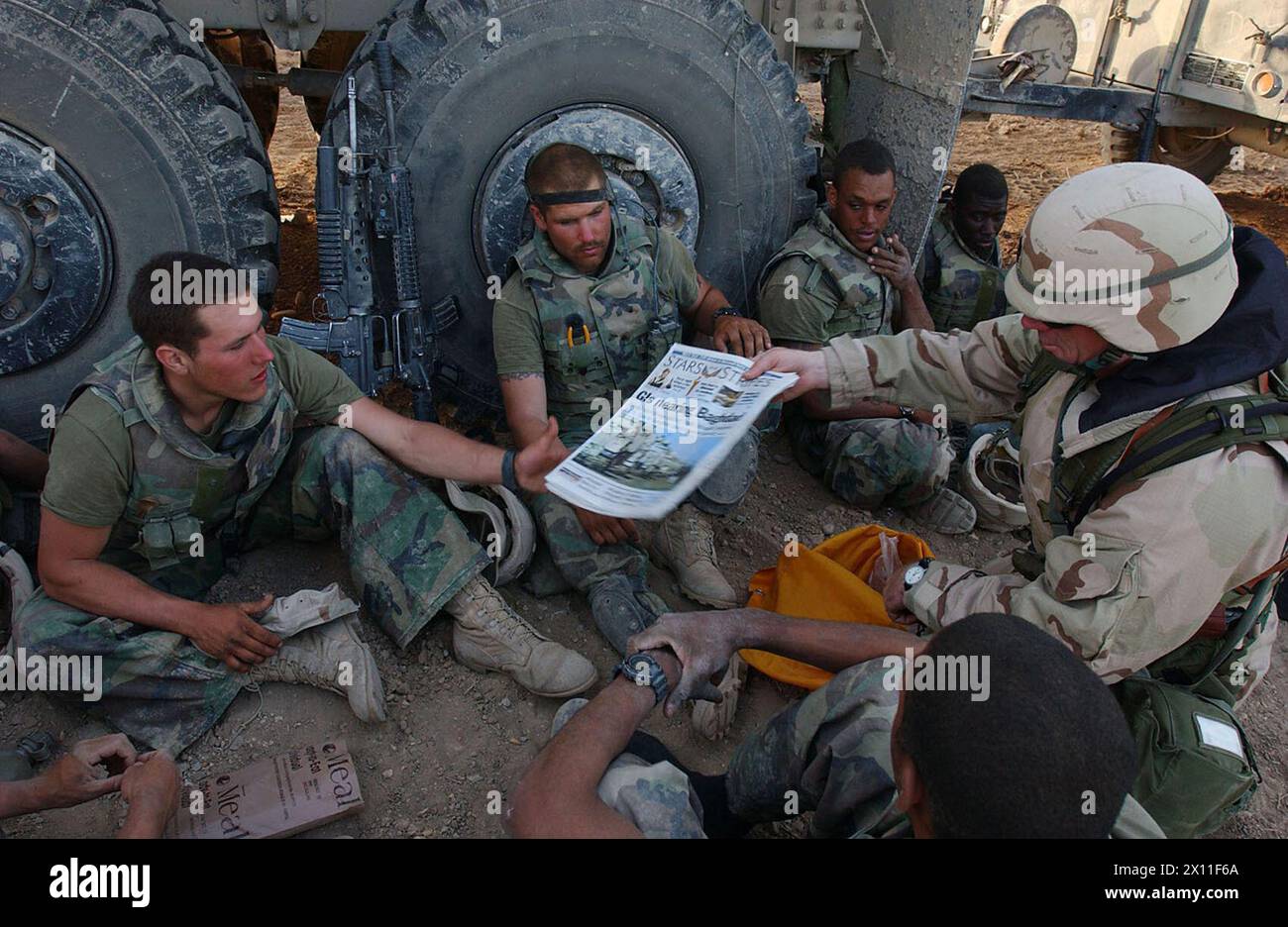 Command Sgt. Maj. John Sparks delivers copies of "Stars and Stripes" to ...