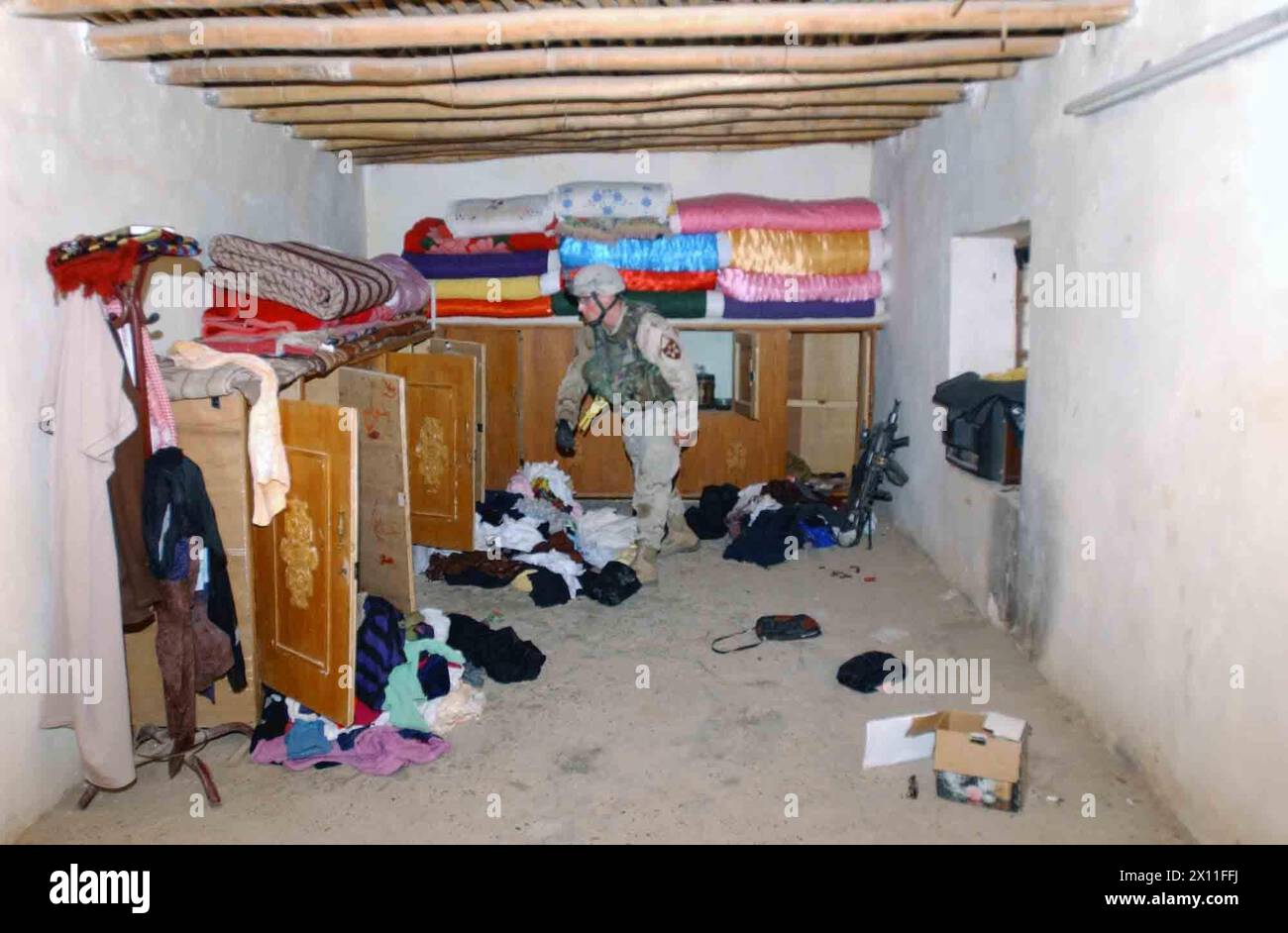 Spc. Zane Shuman, from Troy, Ohio, searches a home in the western ...