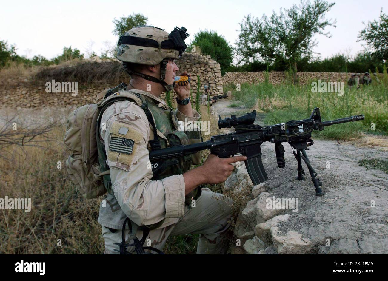Staff Sgt. Strate Flessas communicates to his fellow squad members ...