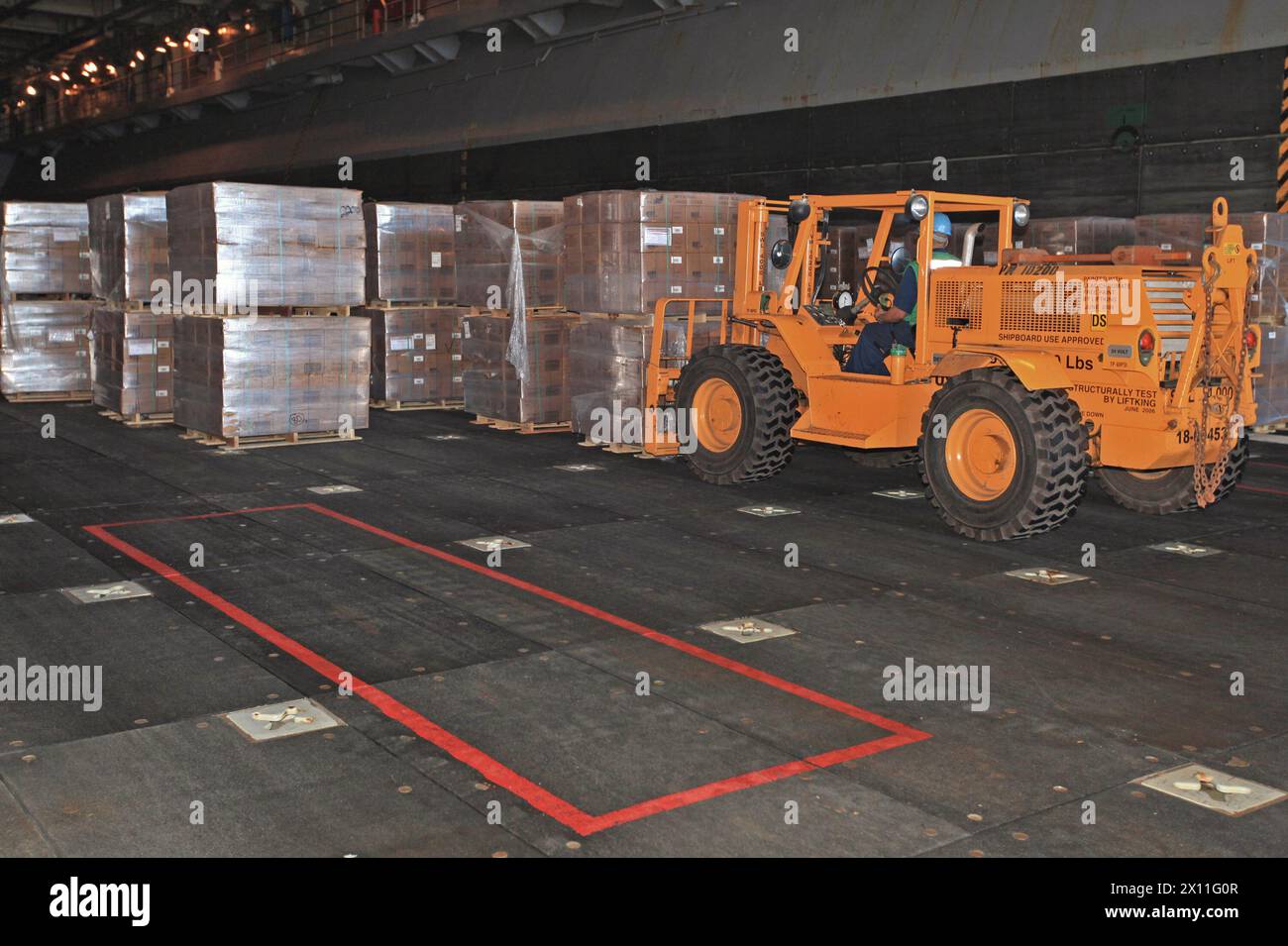 A Navy forklift operator with the USS Bataan, amphibious assault ship ...