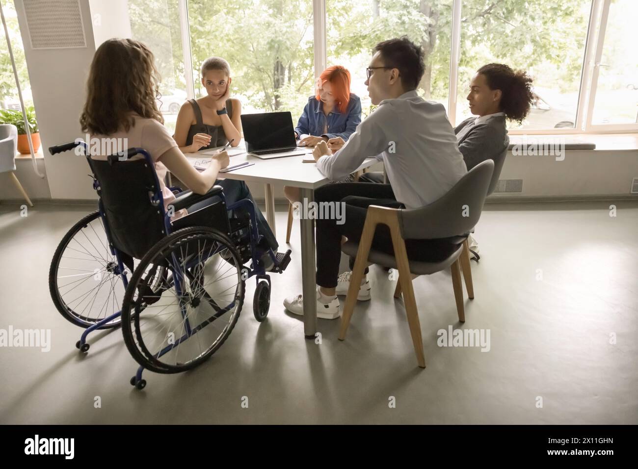 Five students and girl with disability studying in classroom Stock ...