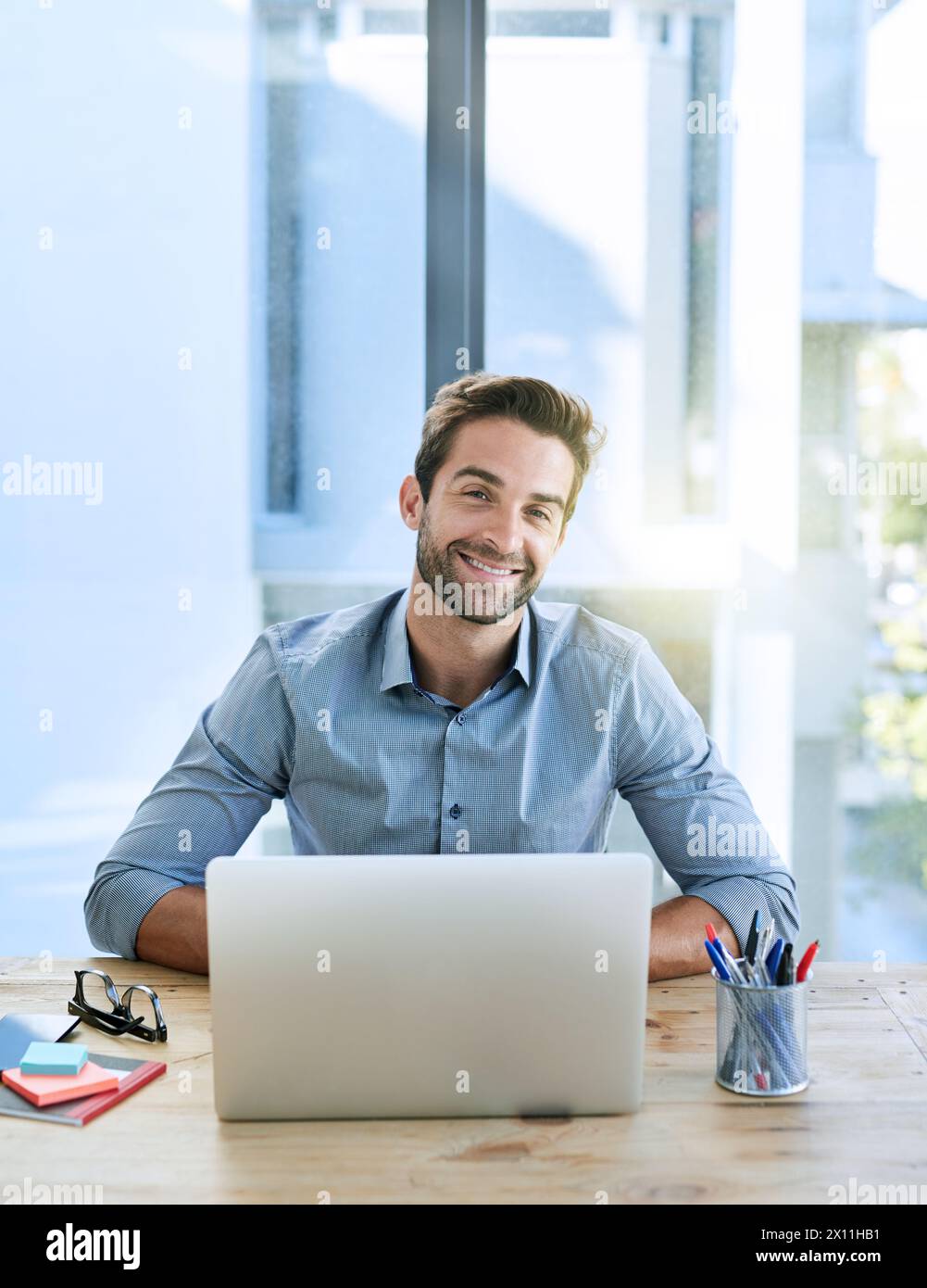 Portrait, typing or business with laptop, man or employee with startup ...