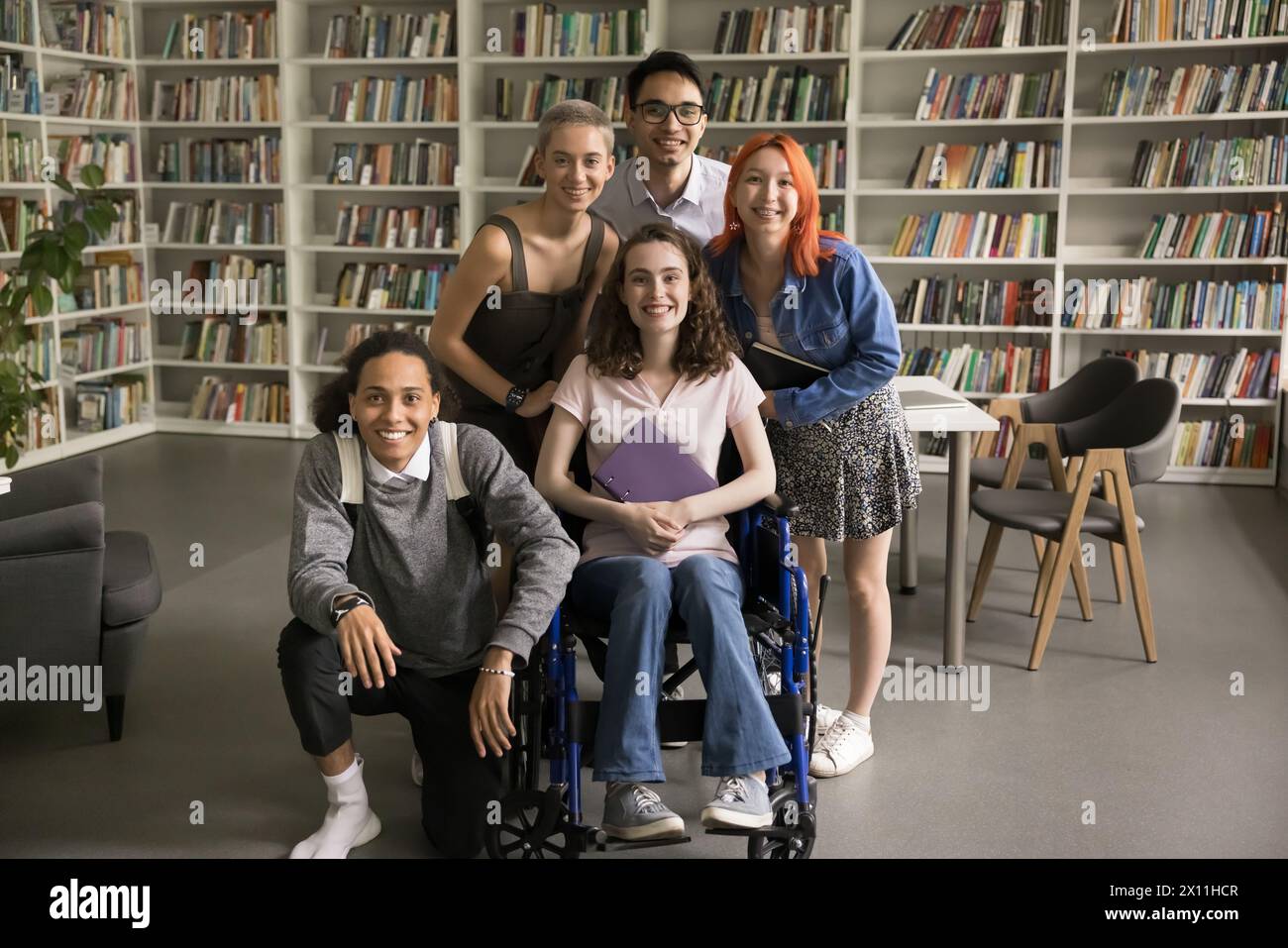 Five students posing for camera in library Stock Photo - Alamy