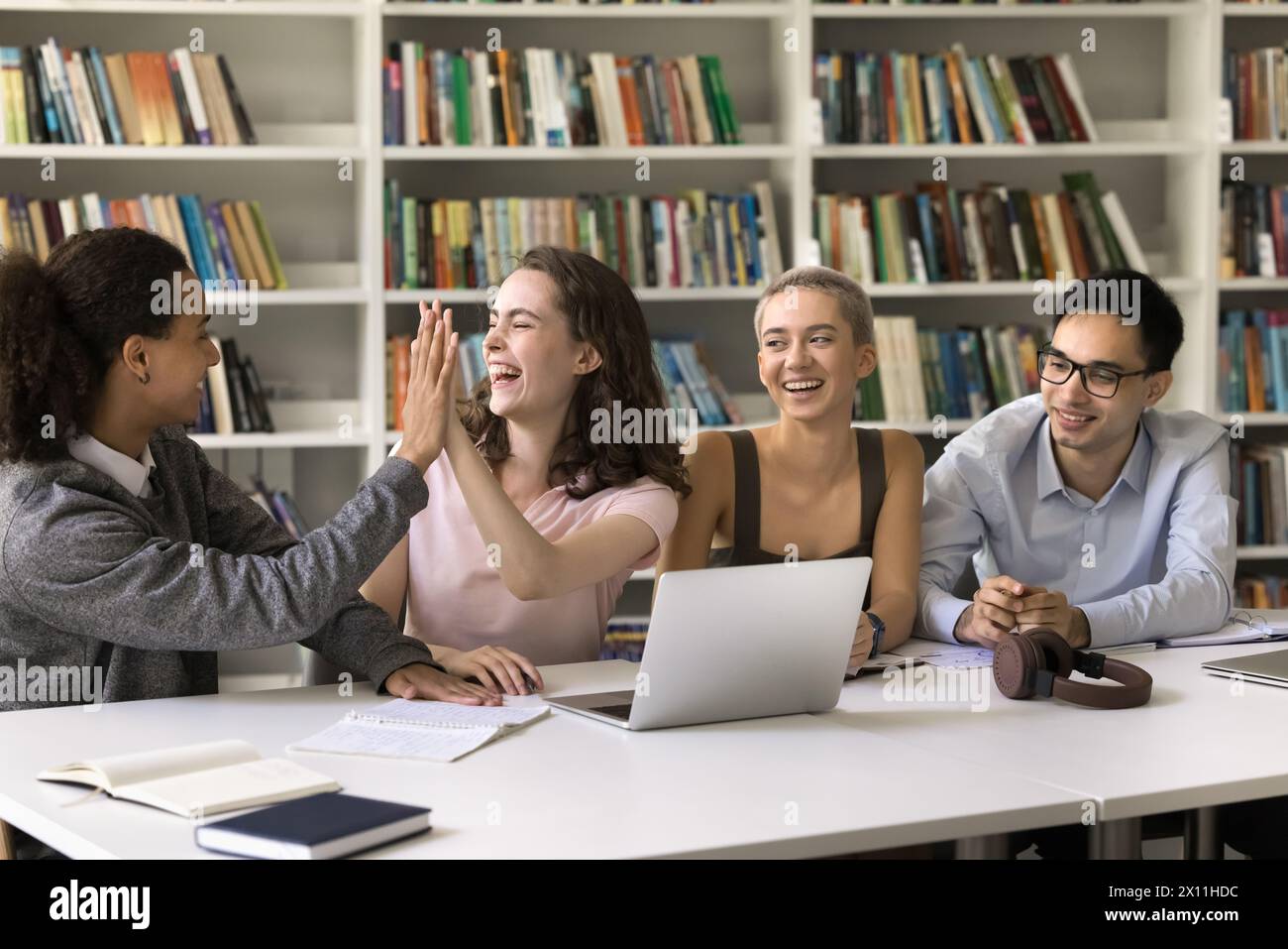 Happy students giving high five celebrate good teamwork results Stock ...