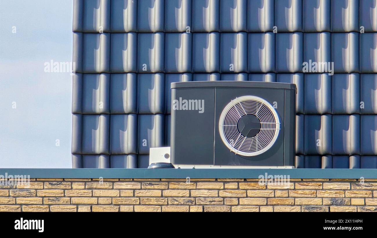 air source heat pump unit installed outdoors at a modern home with ...