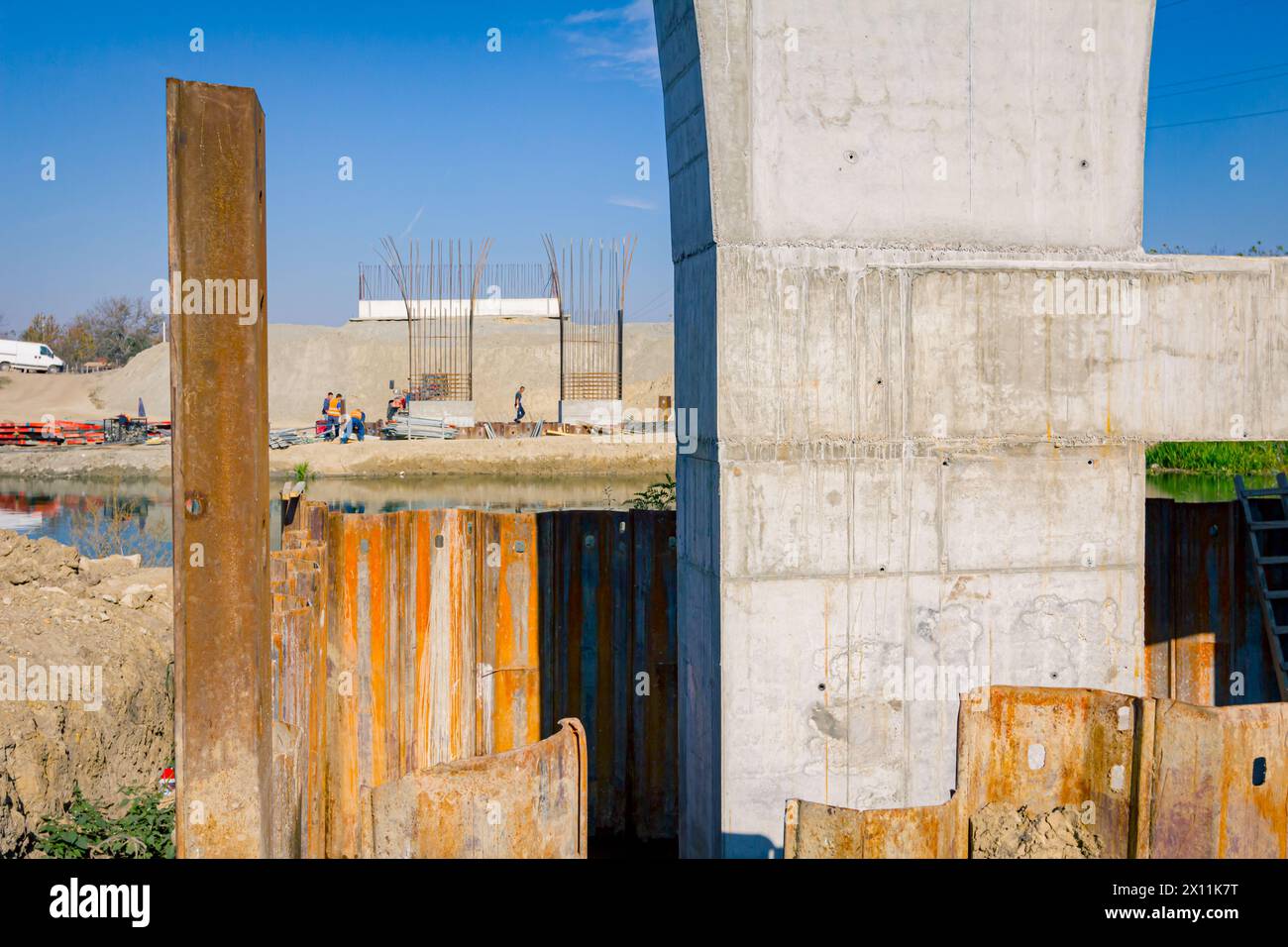 Close up shot of large modern gray concrete bridge pillar in foundation ...