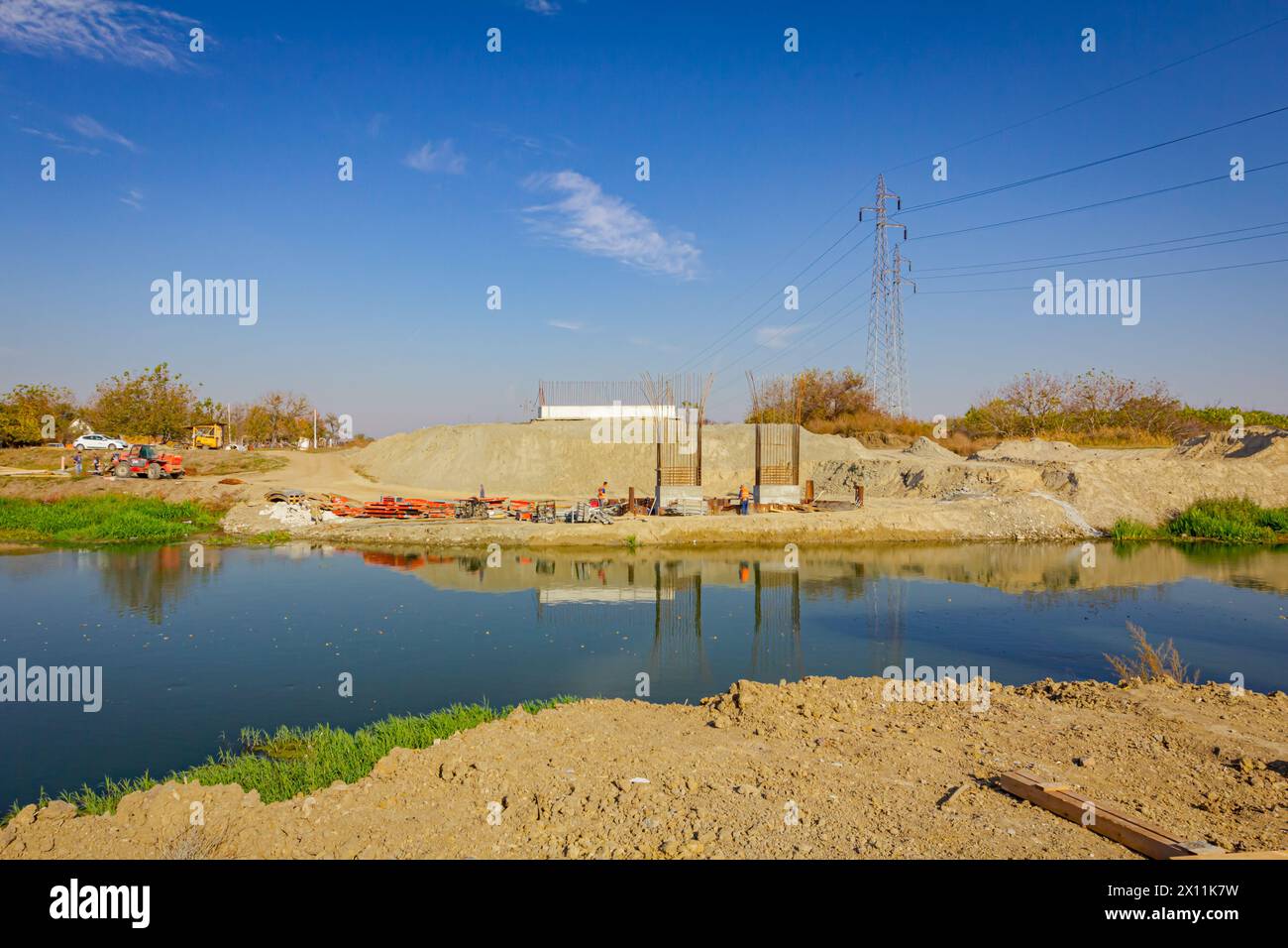 Reinforced concrete bridge pillars under construction across the river ...