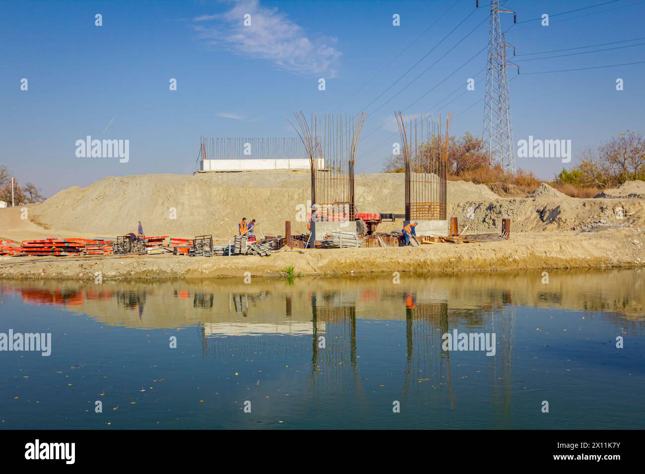 Reinforced concrete bridge pillars under construction across the river ...