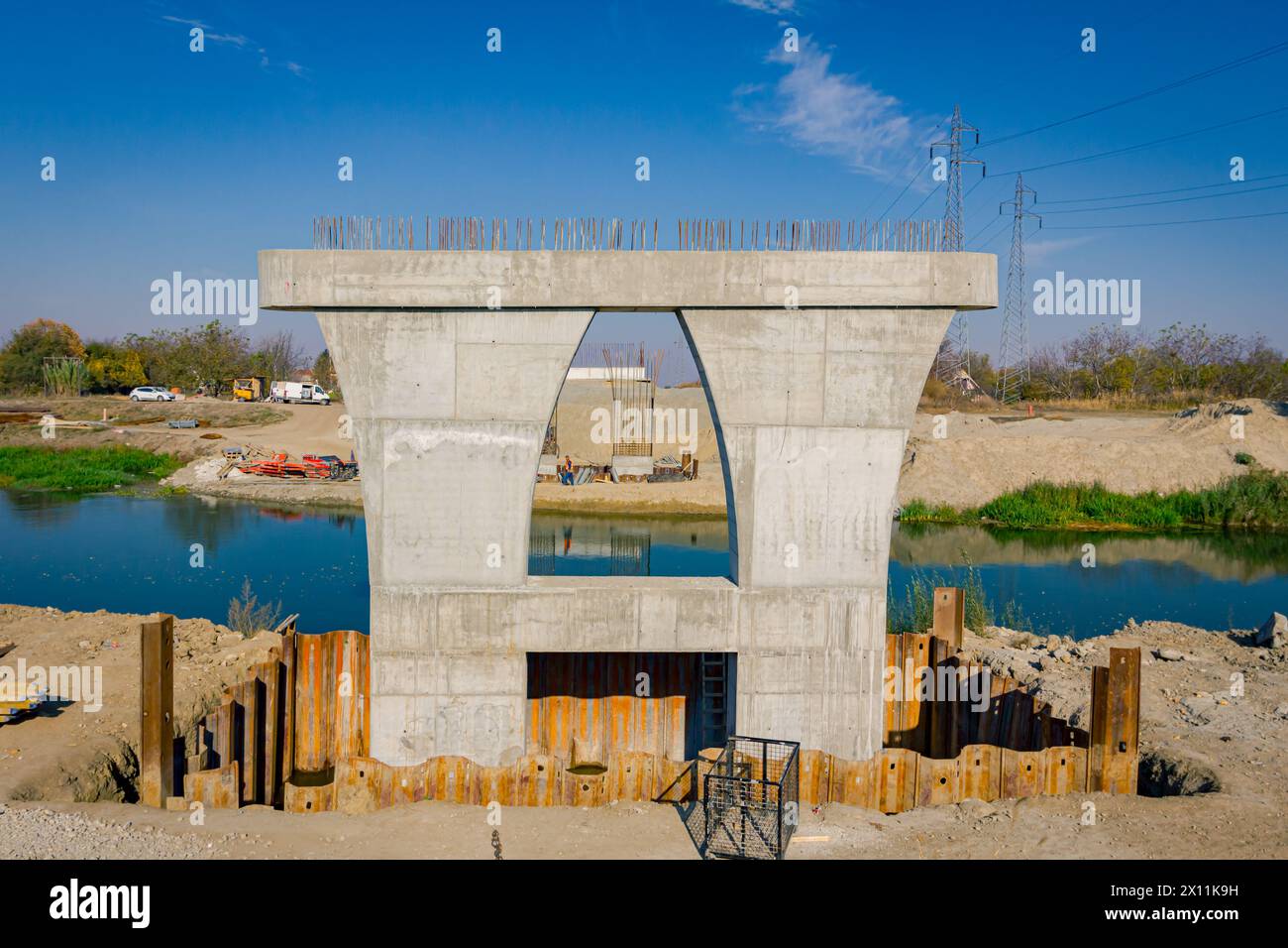 Large modern gray concrete bridge pillar in foundation surrounded by ...