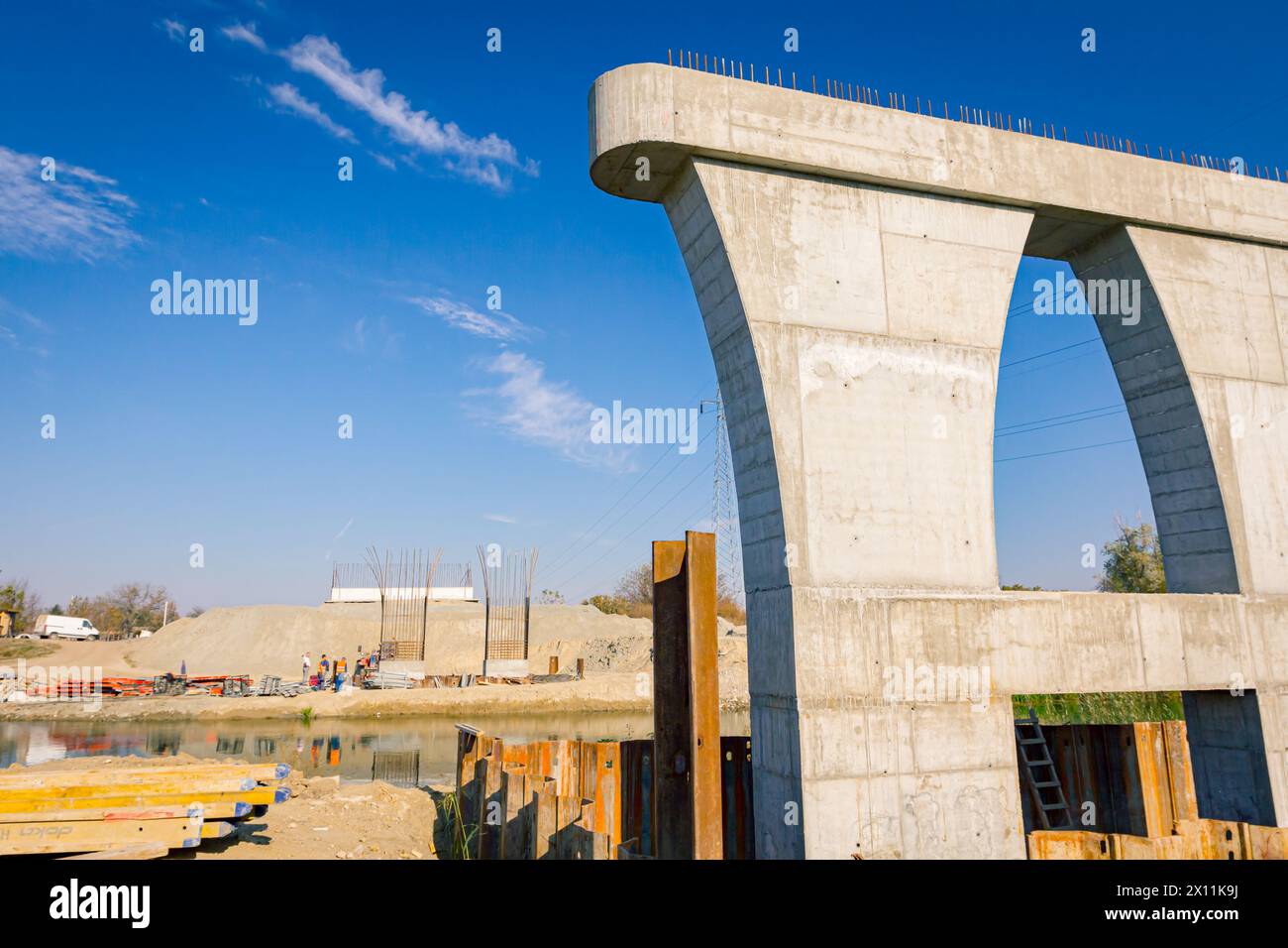 Large modern gray concrete pillar in foundation surrounded by metal ...