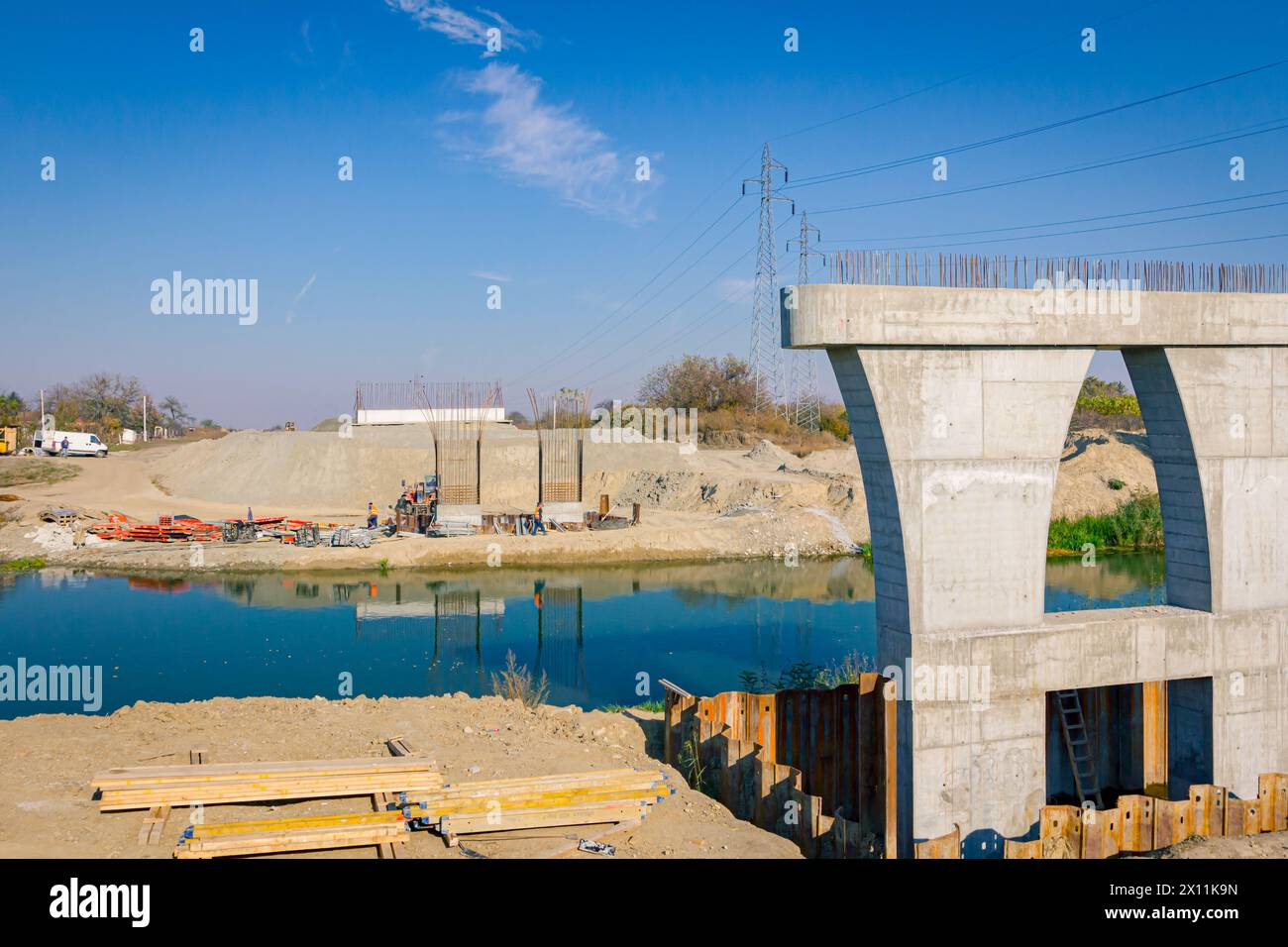 Large modern gray concrete pillar in foundation surrounded by metal ...