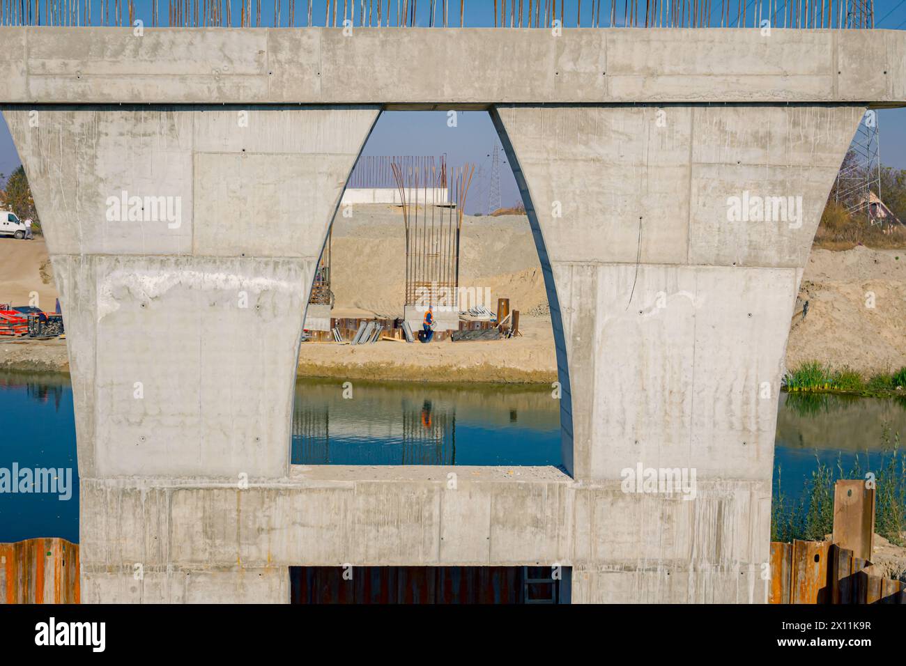 View on reinforced pillar under construction across the river through a ...