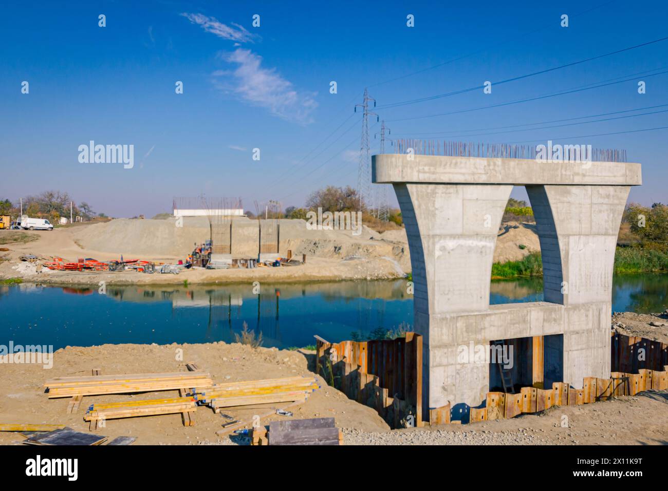 Large modern gray concrete pillar in foundation surrounded by metal ...