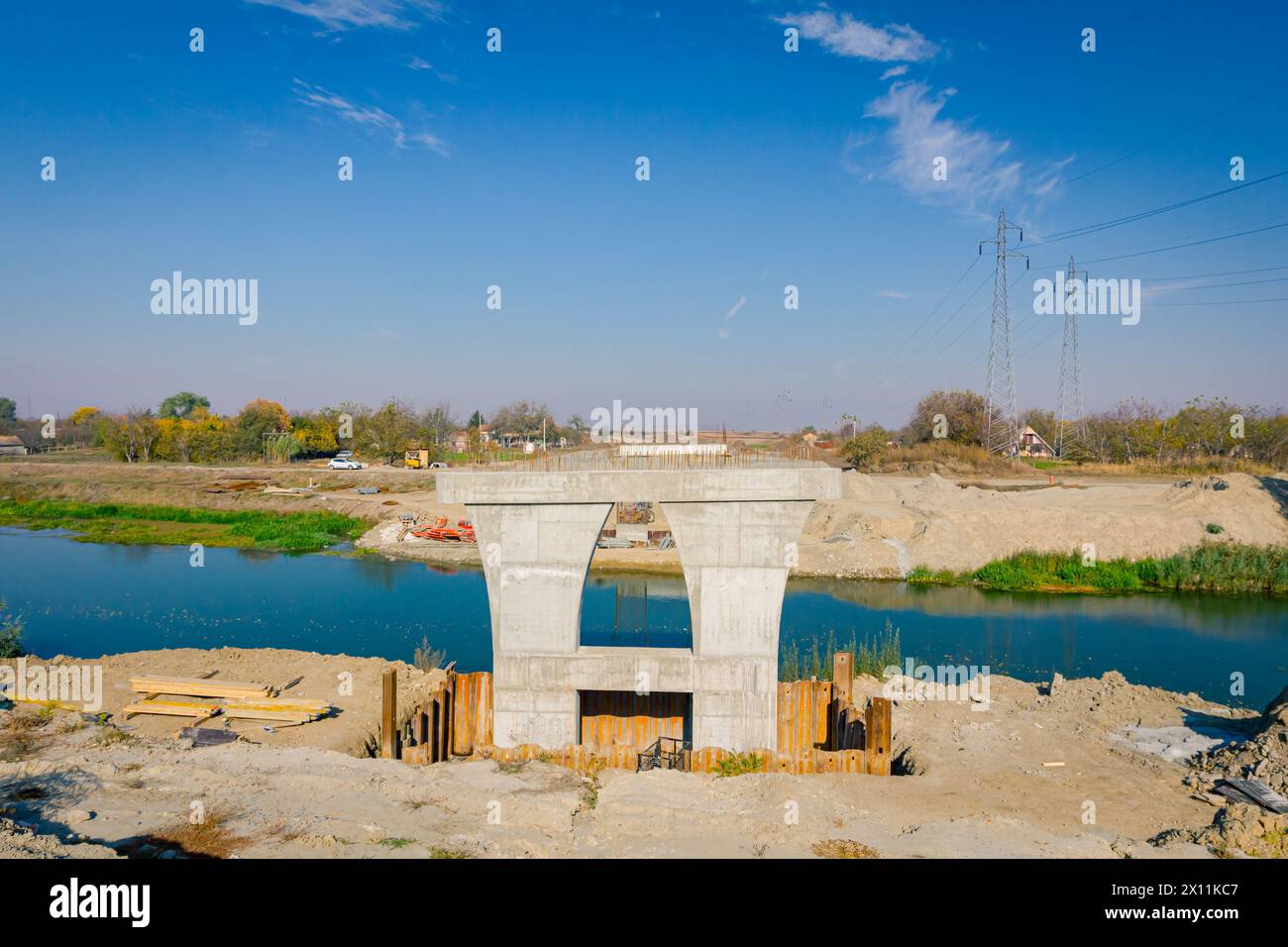 Large modern gray concrete pillar in foundation surrounded by metal ...