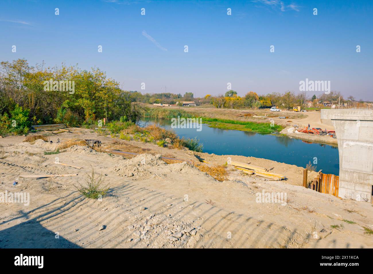 Large modern gray concrete pillar in foundation surrounded by metal ...