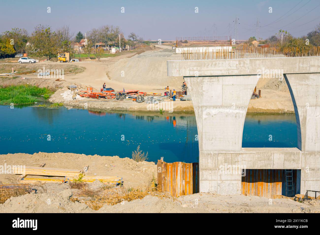 Large modern gray concrete pillar in foundation surrounded by metal ...