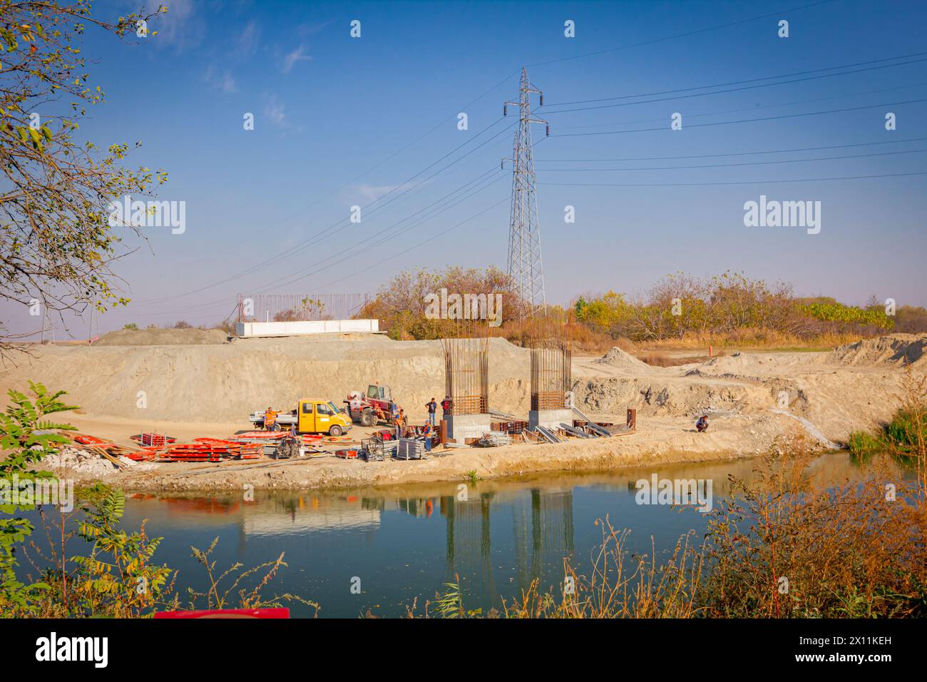 Reinforced concrete bridge pillars under construction across the river ...