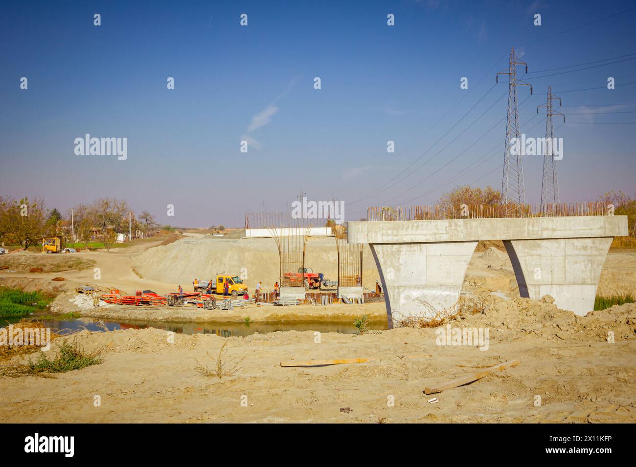 Large modern gray concrete bridge pillar in foundation surrounded by ...
