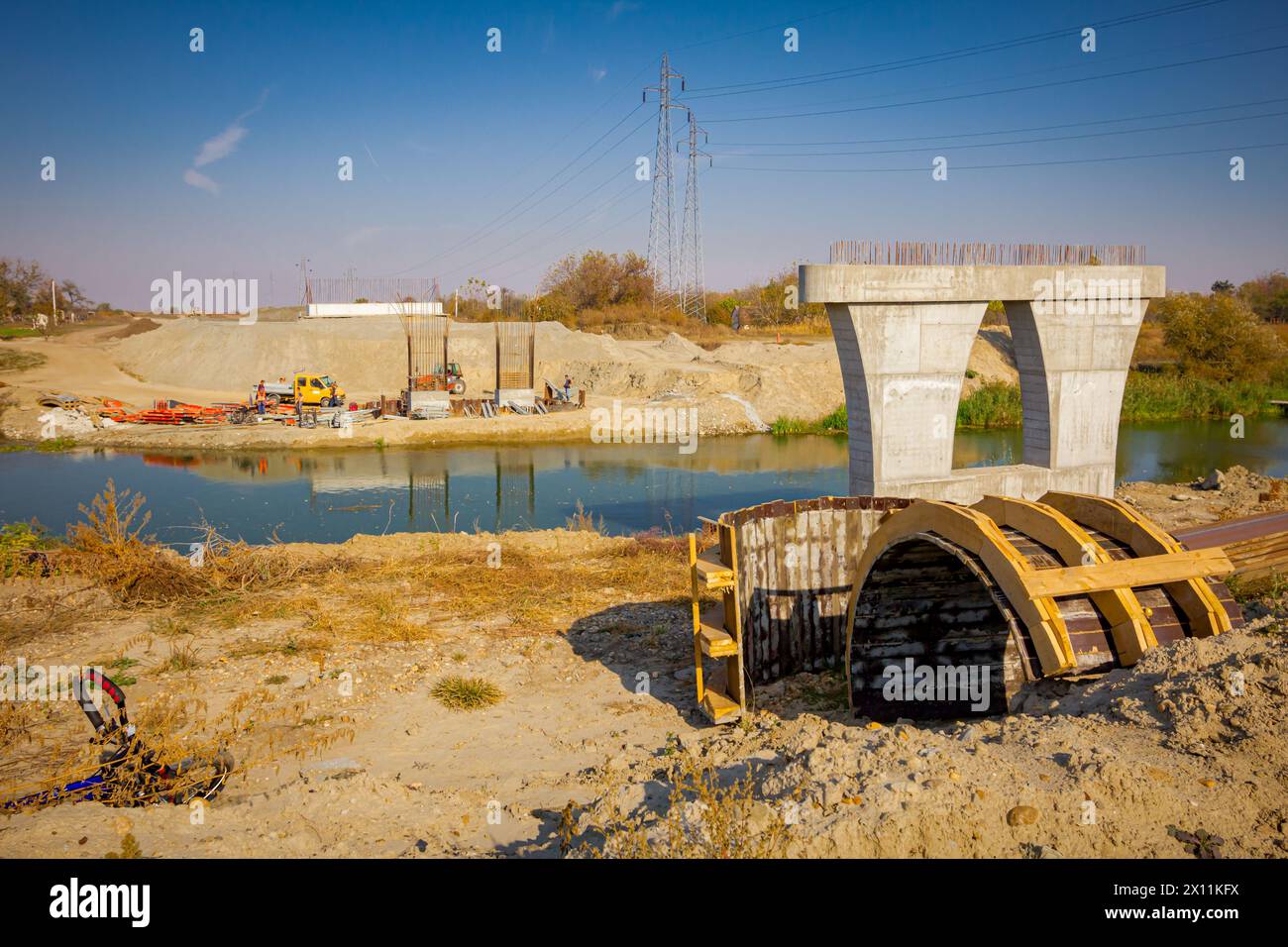 Wooden arch molds for bridge, large modern gray concrete pillar in ...