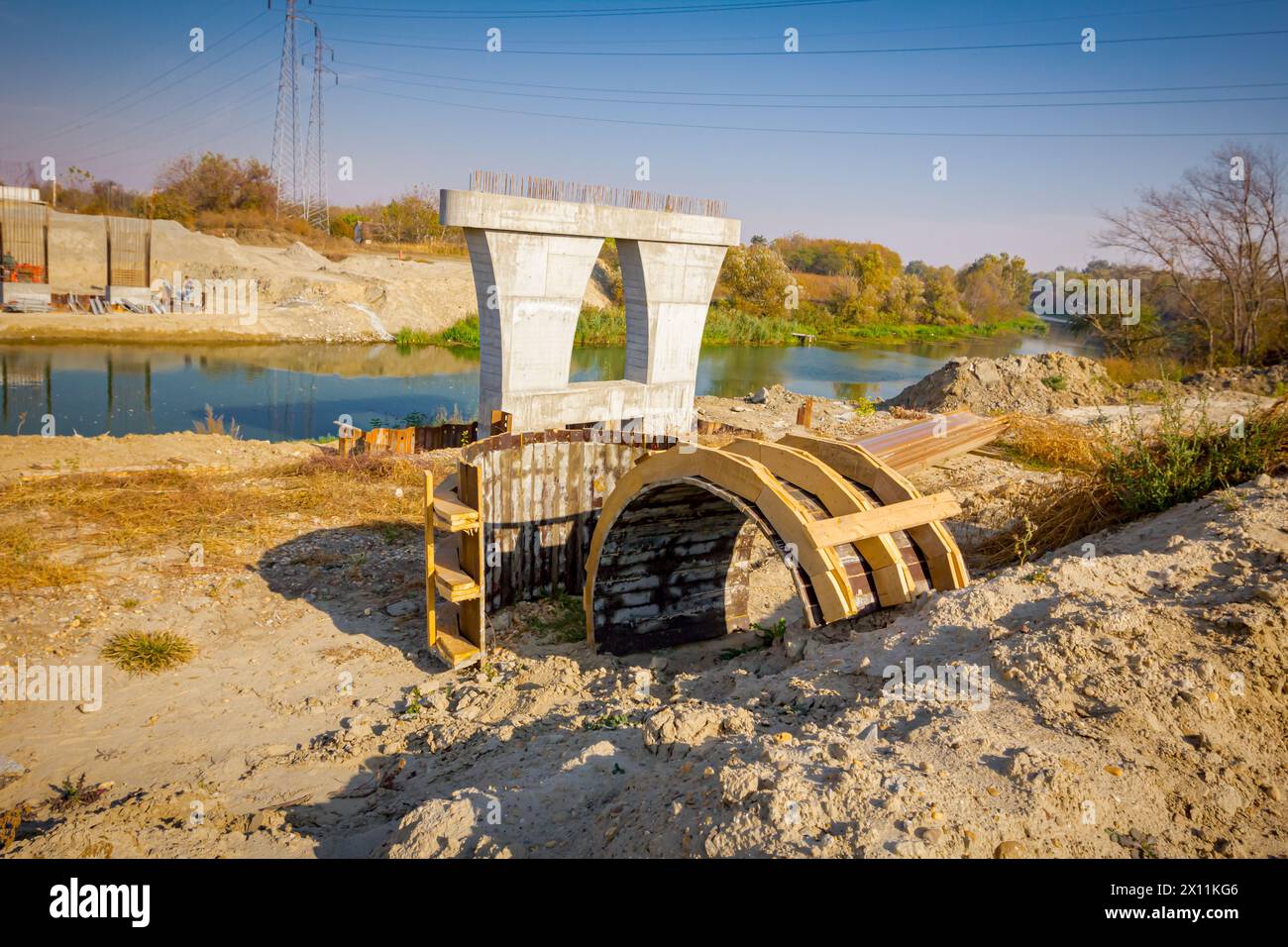 Wooden arch molds for bridge, large modern gray concrete pillar in ...