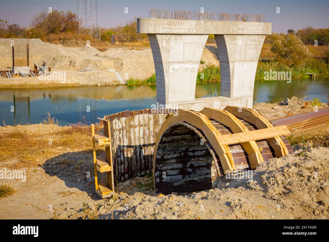Wooden arch molds for bridge, large modern gray concrete pillar in ...