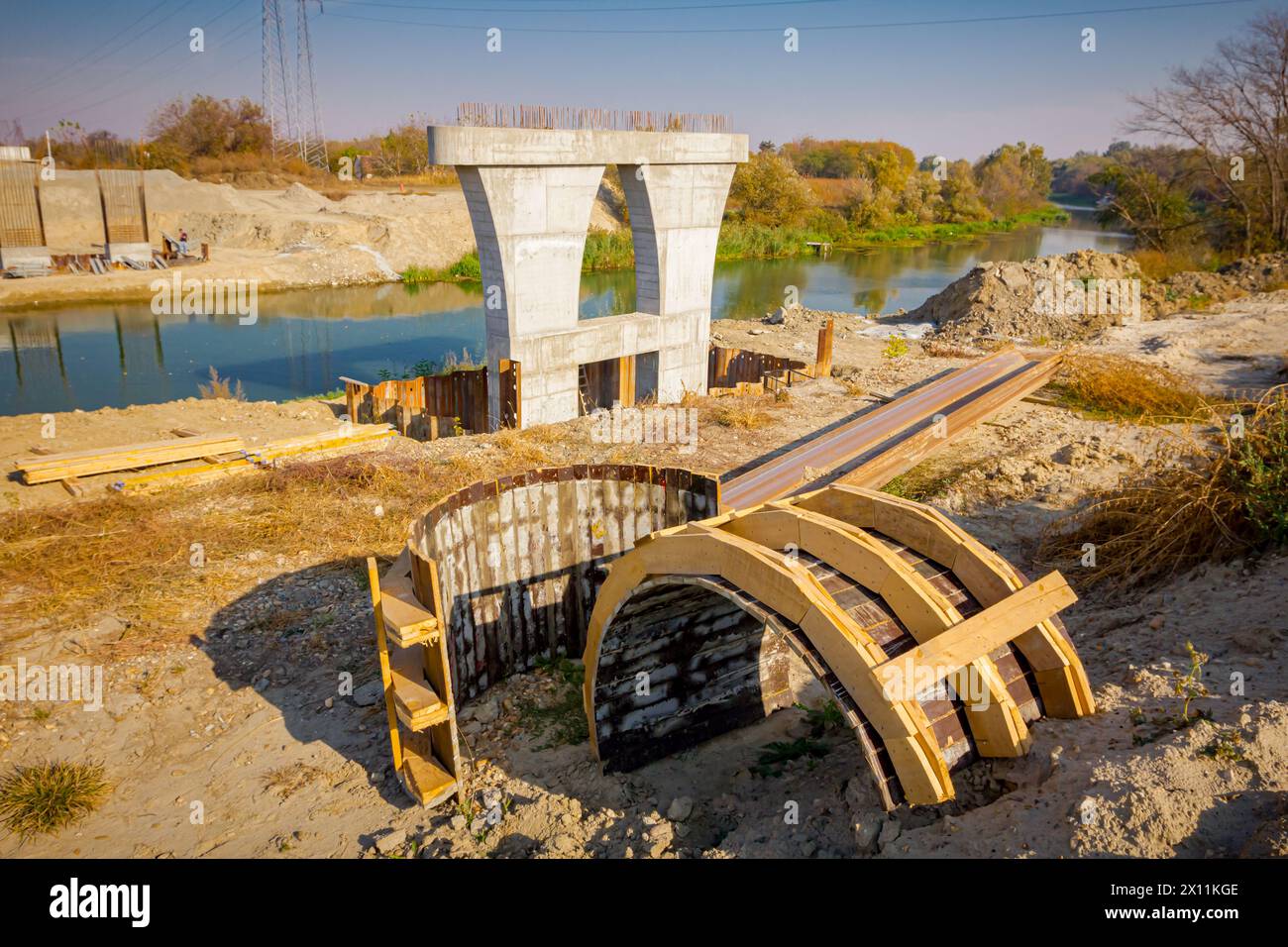 Wooden arch molds for bridge, large modern gray concrete pillar in ...