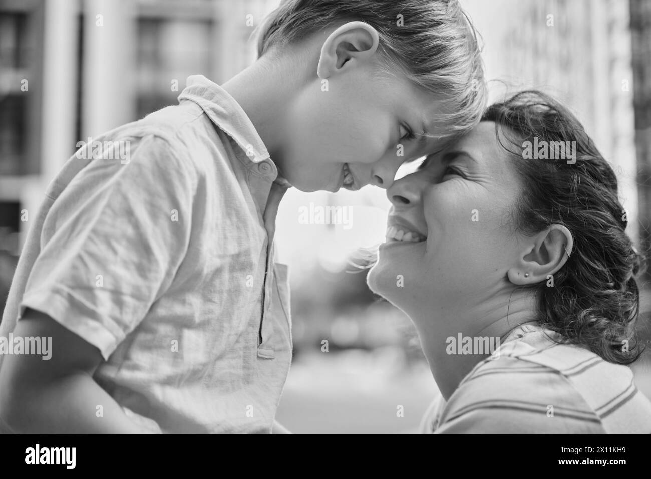 Adorable mother and son smiling happy having fun at city background ...