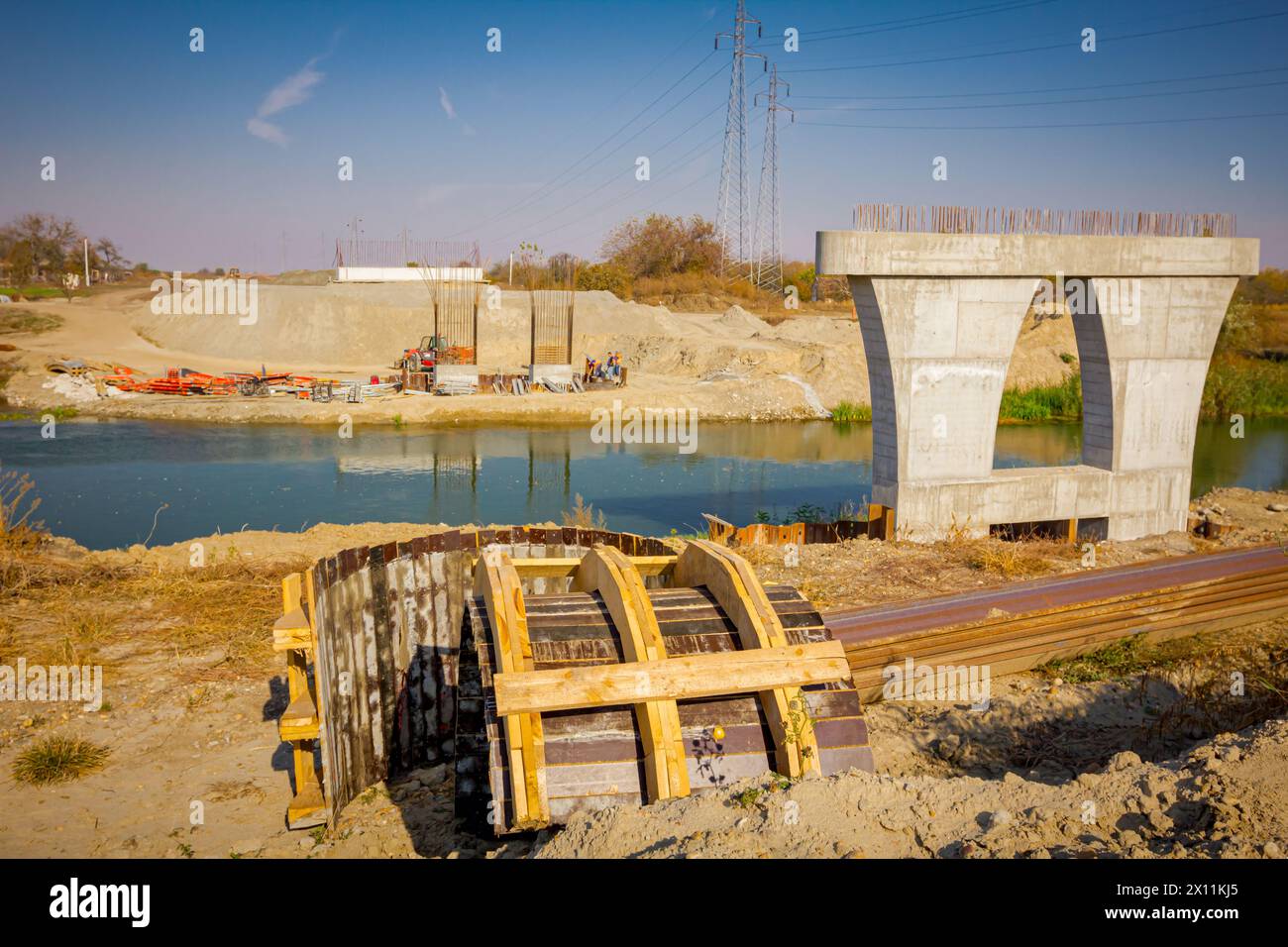 Wooden arch molds for bridge, large modern gray concrete pillar in ...