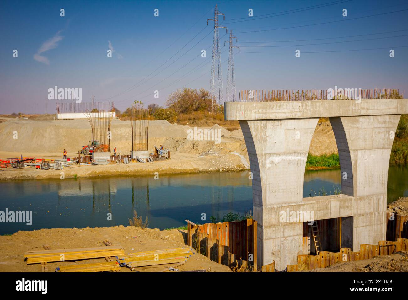 Large modern gray concrete pillar in foundation surrounded by metal ...
