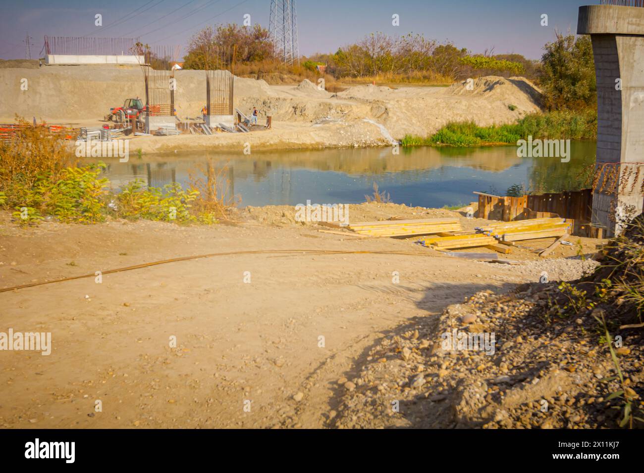 Reinforced concrete bridge pillars under construction across the river ...