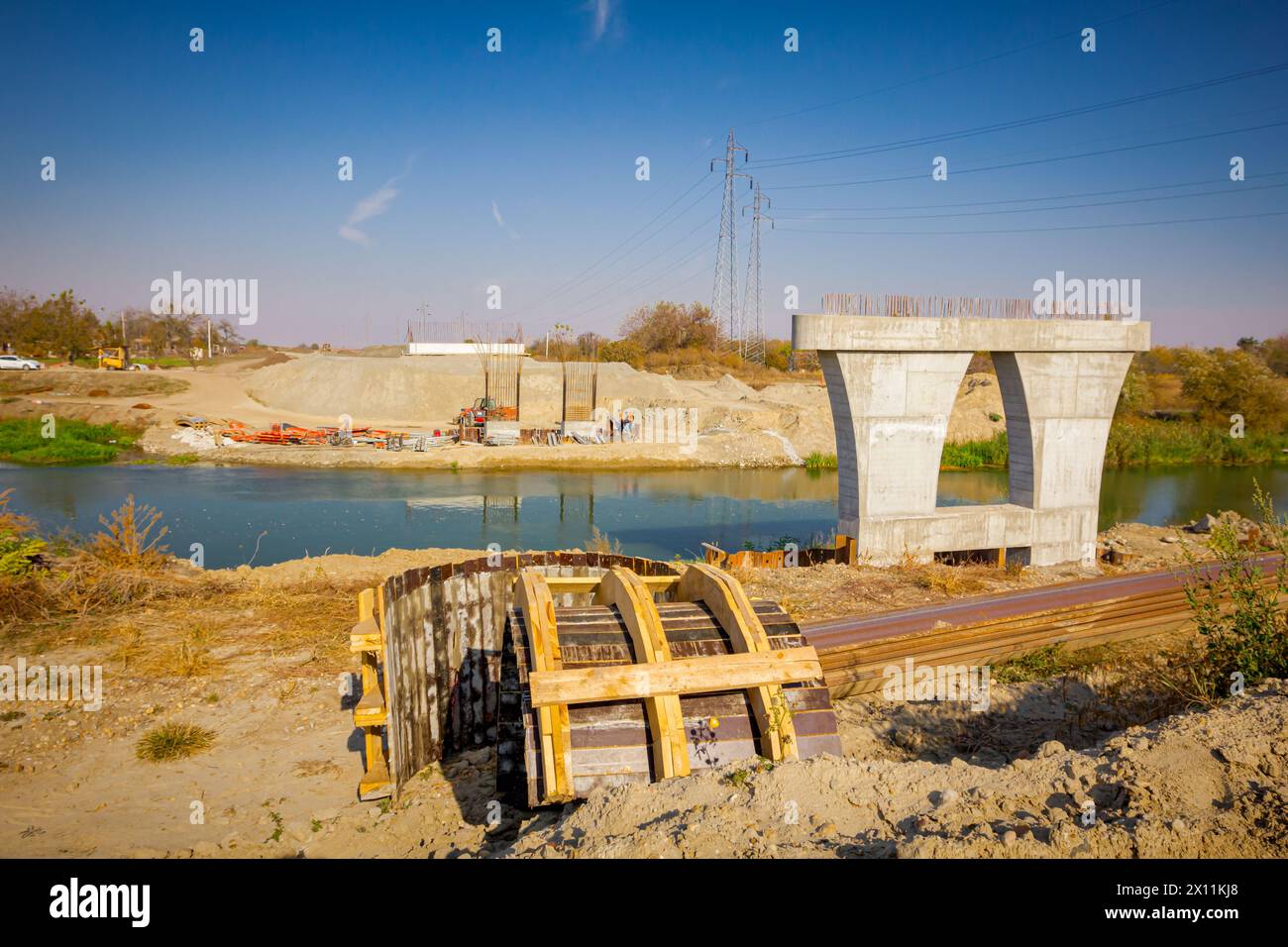 Wooden arch molds for bridge, large modern gray concrete pillar in ...