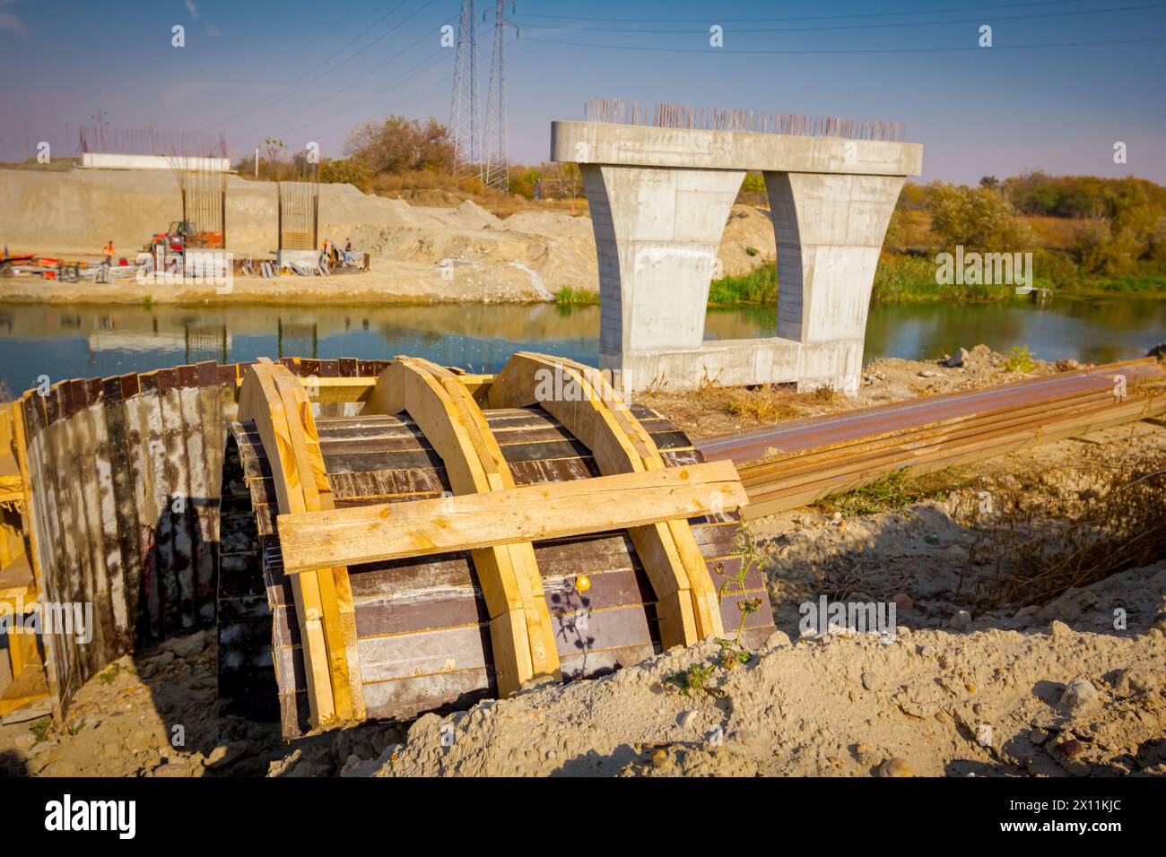 Wooden arch molds for bridge, large modern gray concrete pillar in ...