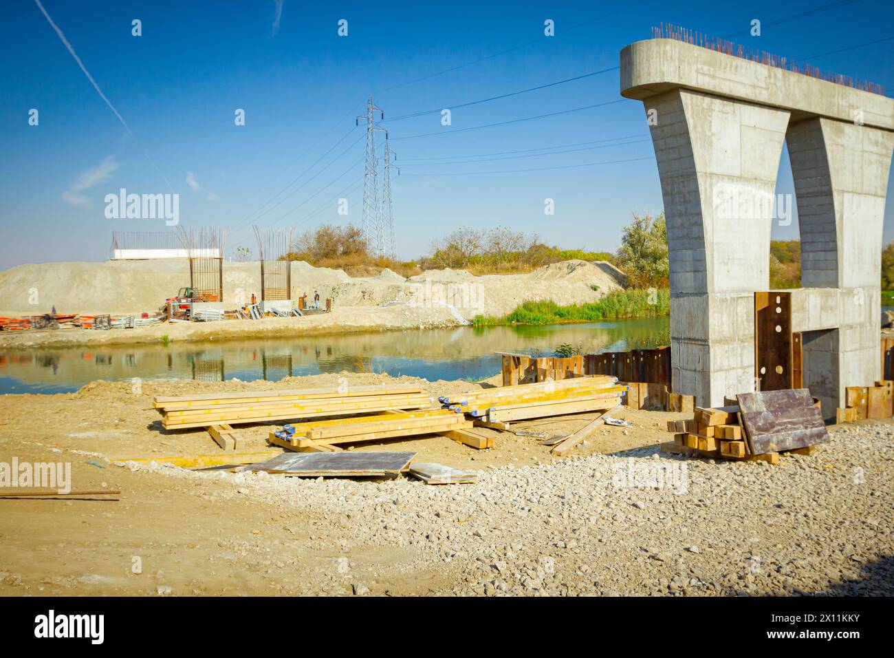 Large modern gray concrete pillar in foundation surrounded by metal ...
