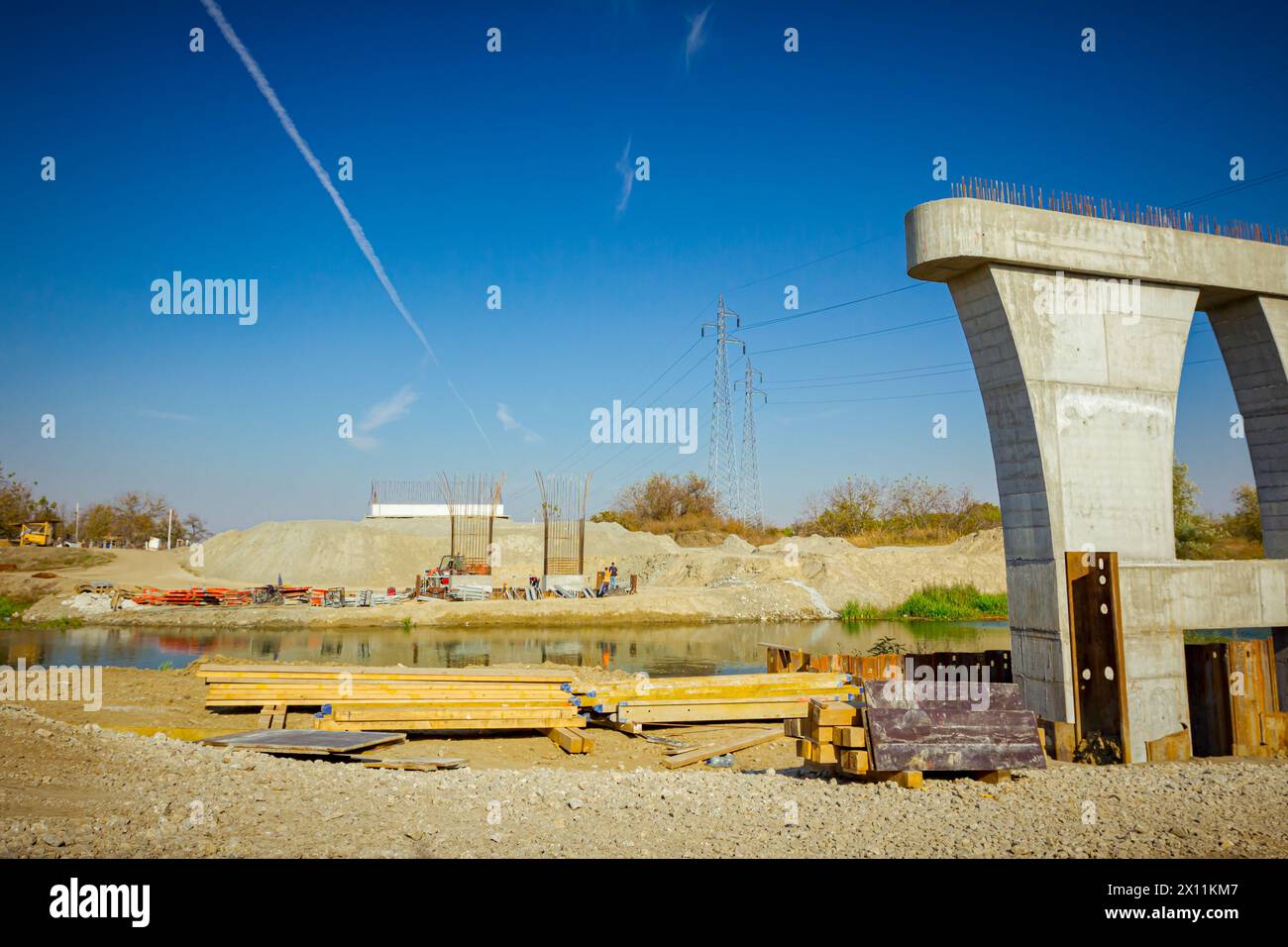 Large modern gray concrete pillar in foundation surrounded by metal ...