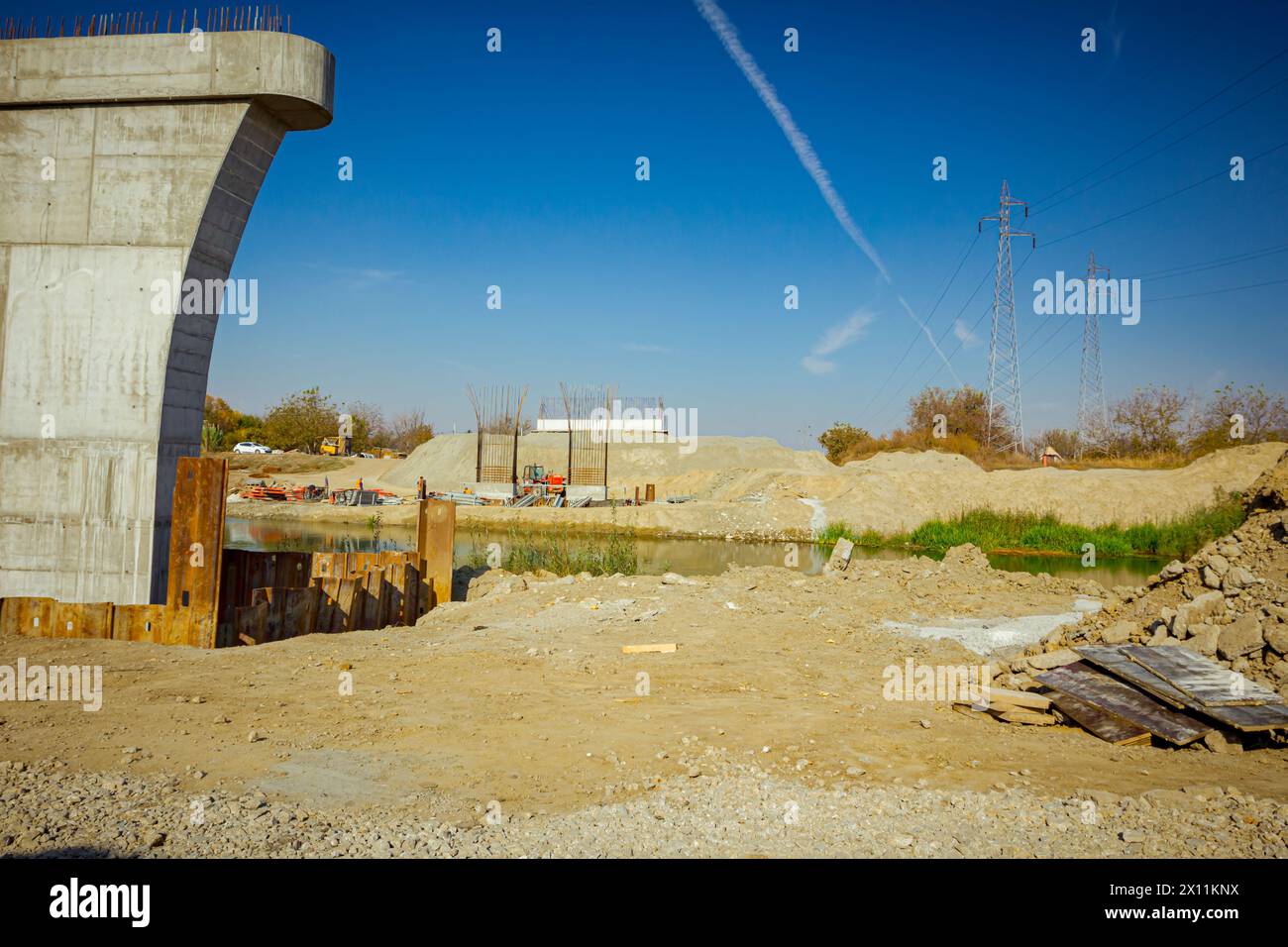 Large modern gray concrete bridge pillar in foundation surrounded by ...