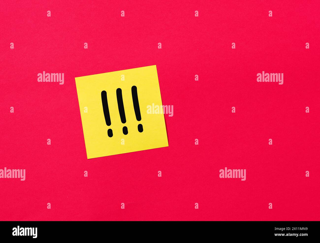 Three handwritten exclamation marks on a yellow sticky note paper ...
