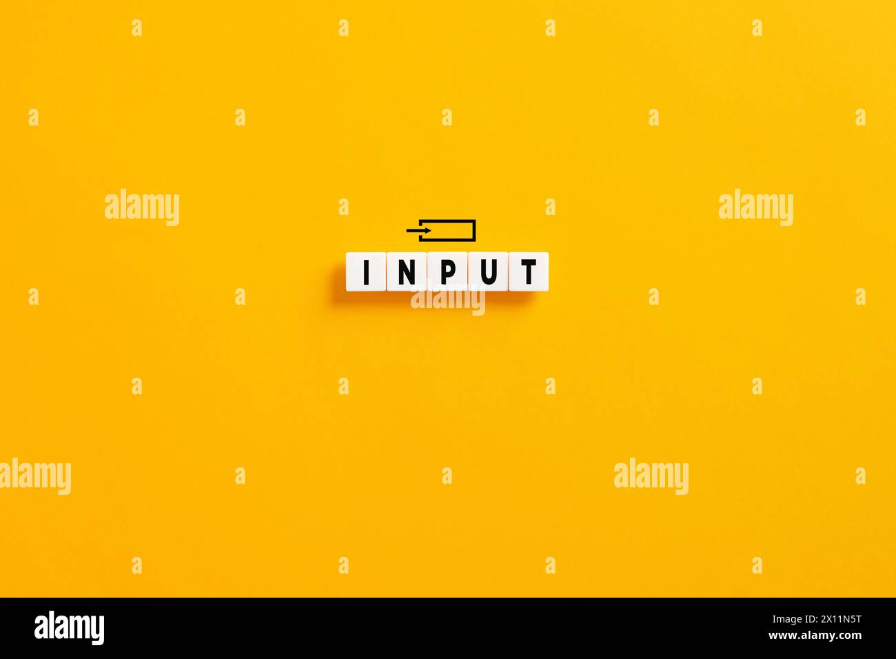 White letter blocks on yellow background with the word input. Business ...