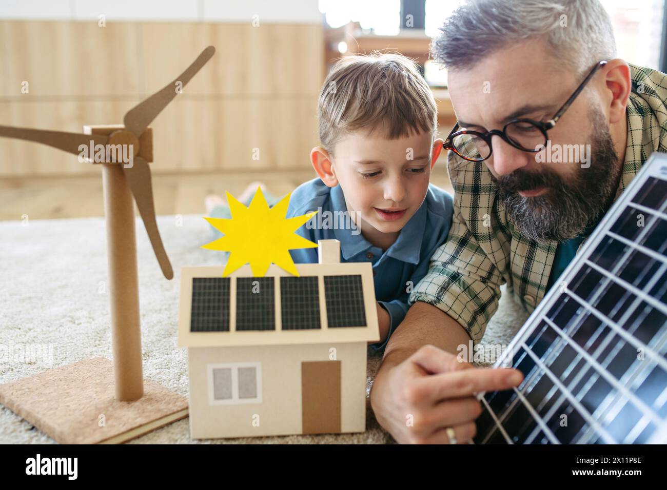 Father explaining renewable energy, solar power and teaching about ...