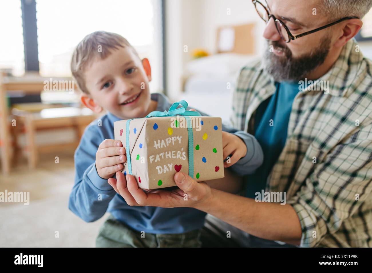 Dad get a handmade gift from little son, present wrapped in diy ...