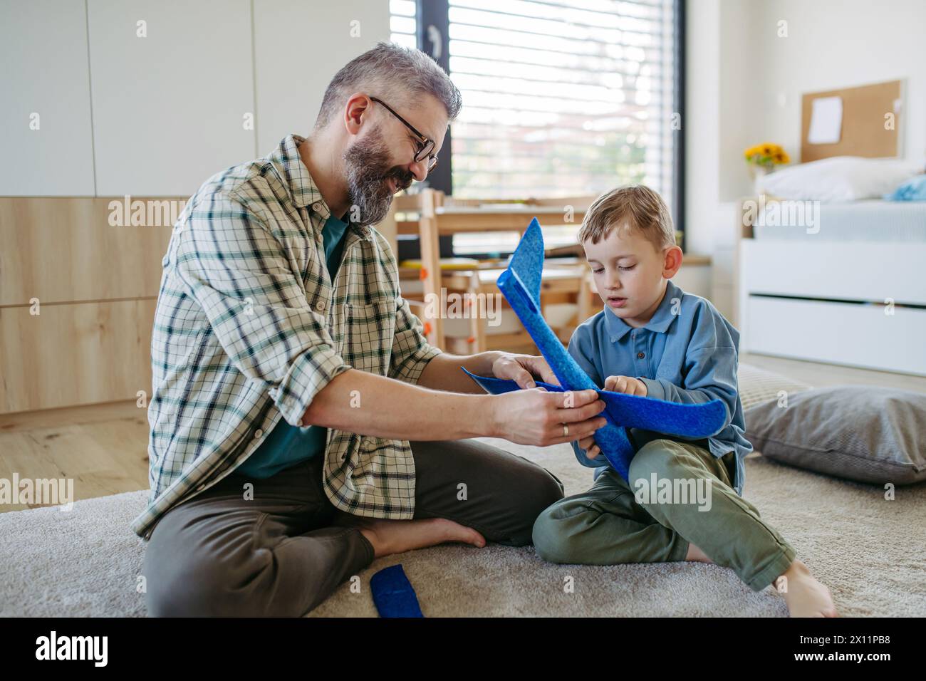 Playing with lightweight styrofoam planes. Playful father and son ...
