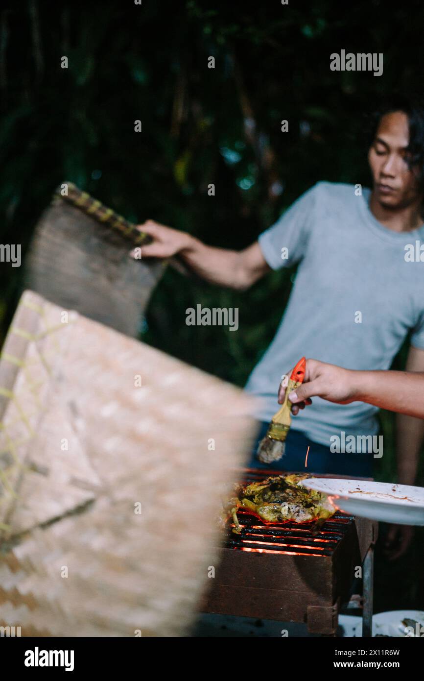 burning chicken meat that has been prepared by an adult man Stock Photo ...